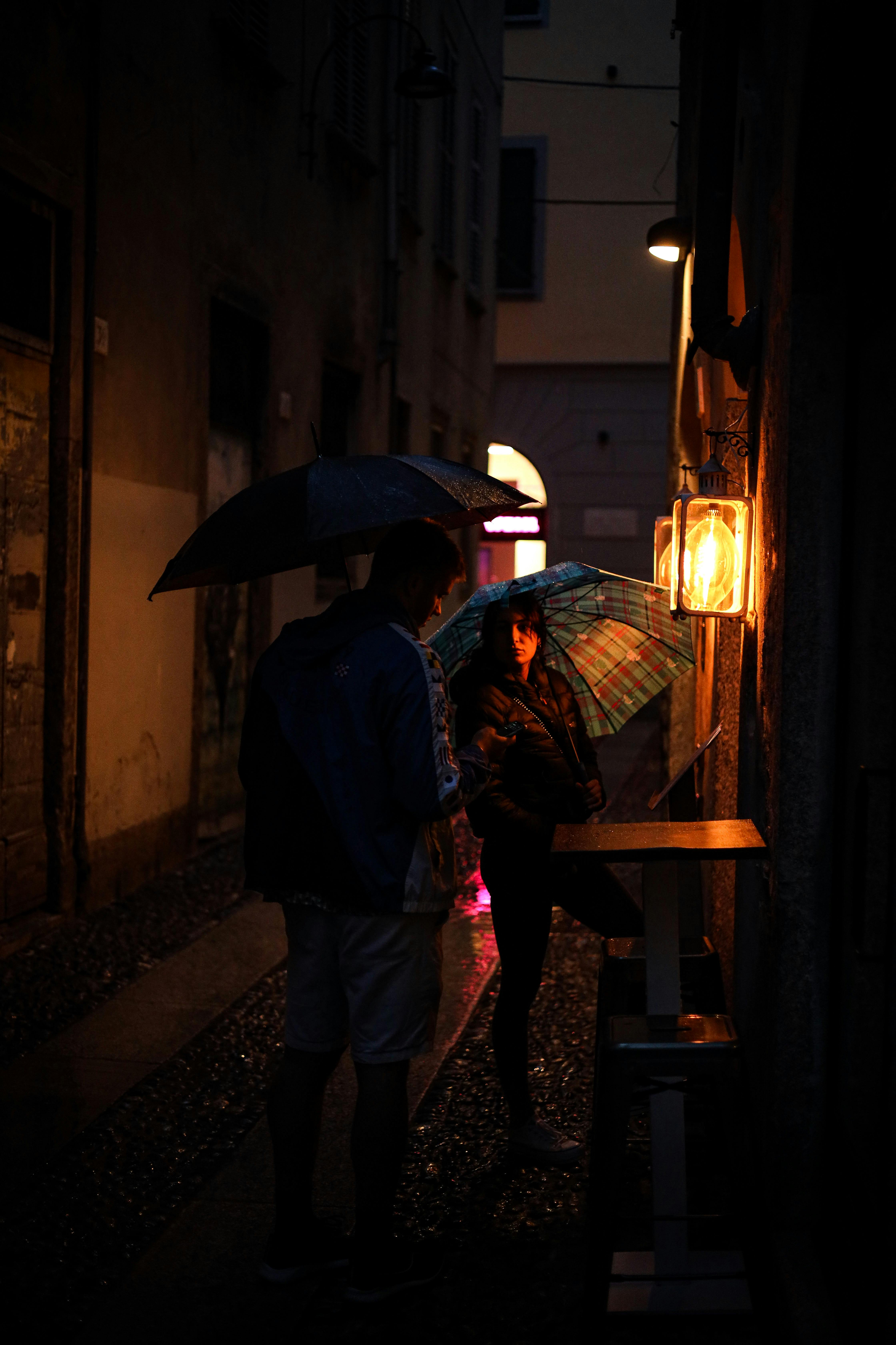 Man Standing in Front of Street Light Turned on · Free Stock Photo