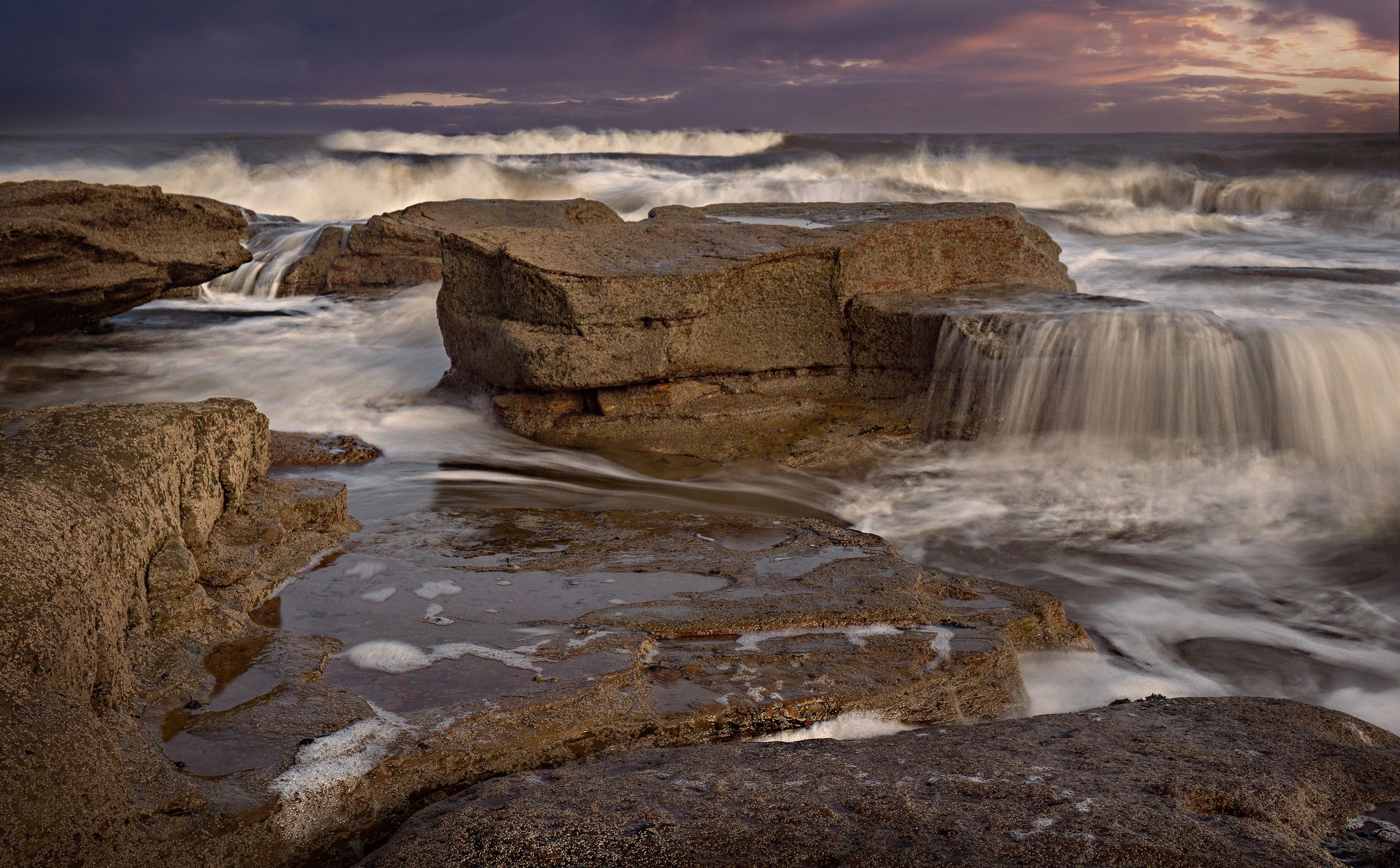 Waterfalls on Rocks in Ocean on Sunset · Free Stock Photo