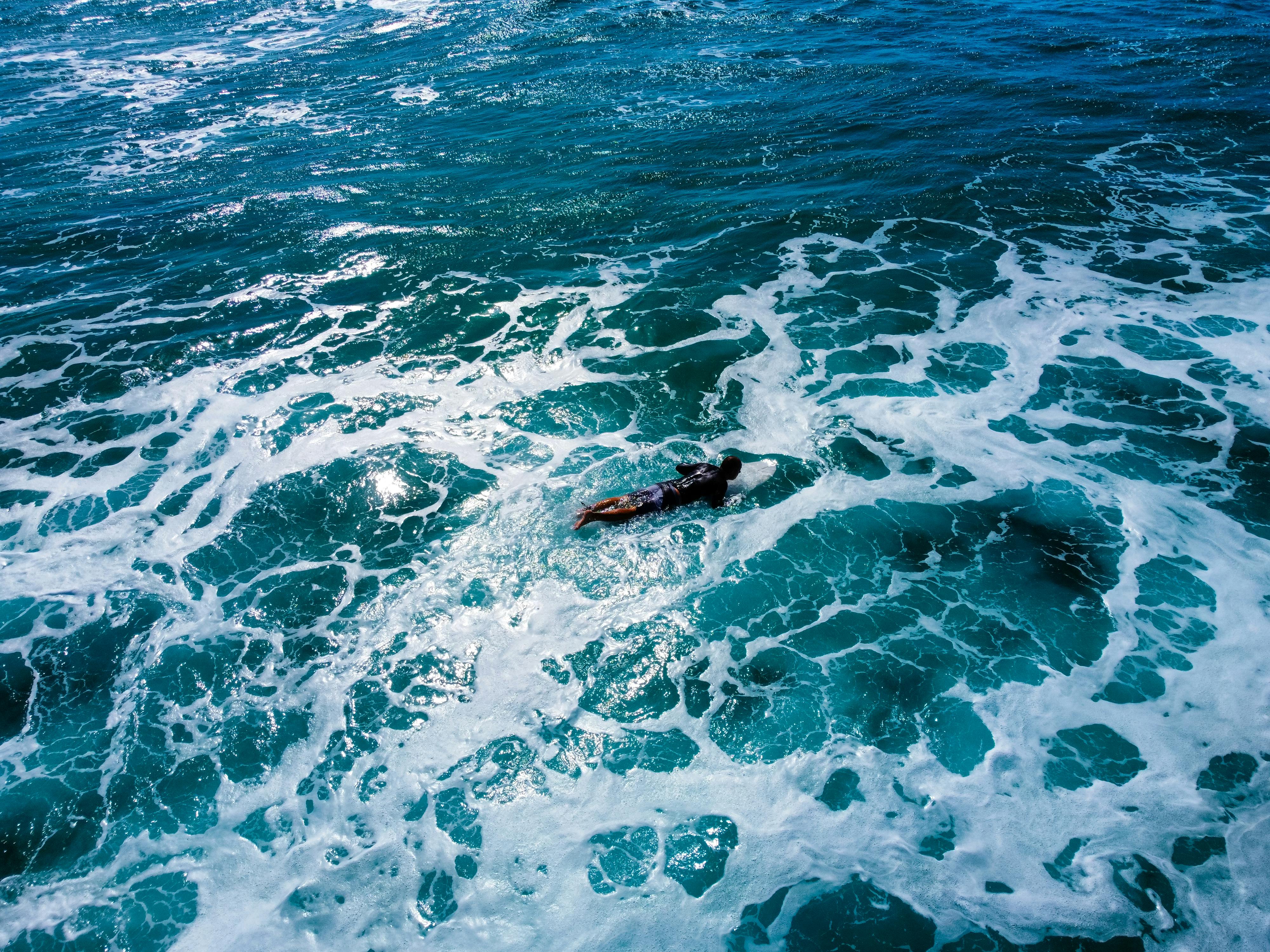 Man Surfing on Blue Sea · Free Stock Photo