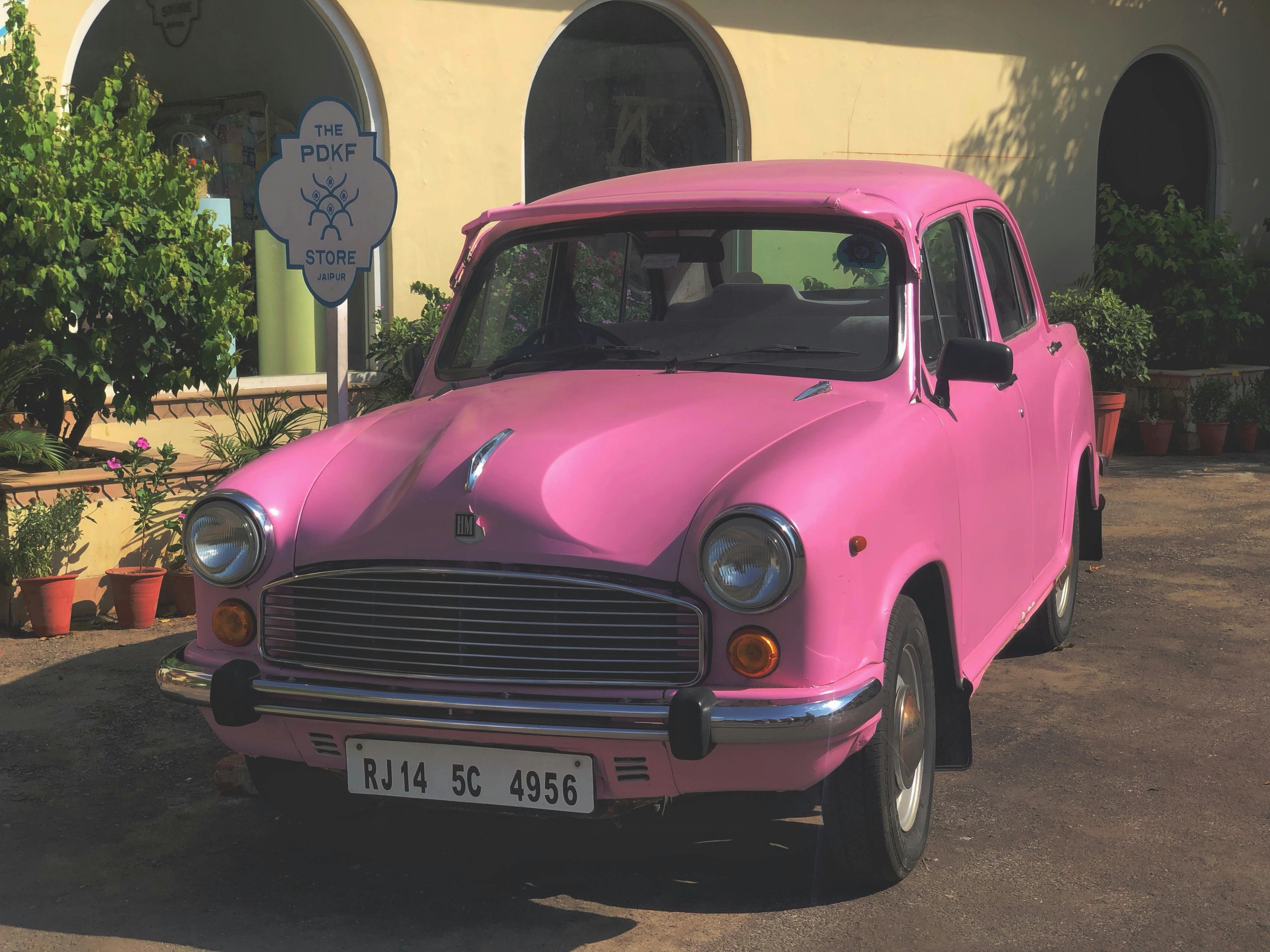 A Pink Vintage Car Parked on the Street · Free Stock Photo