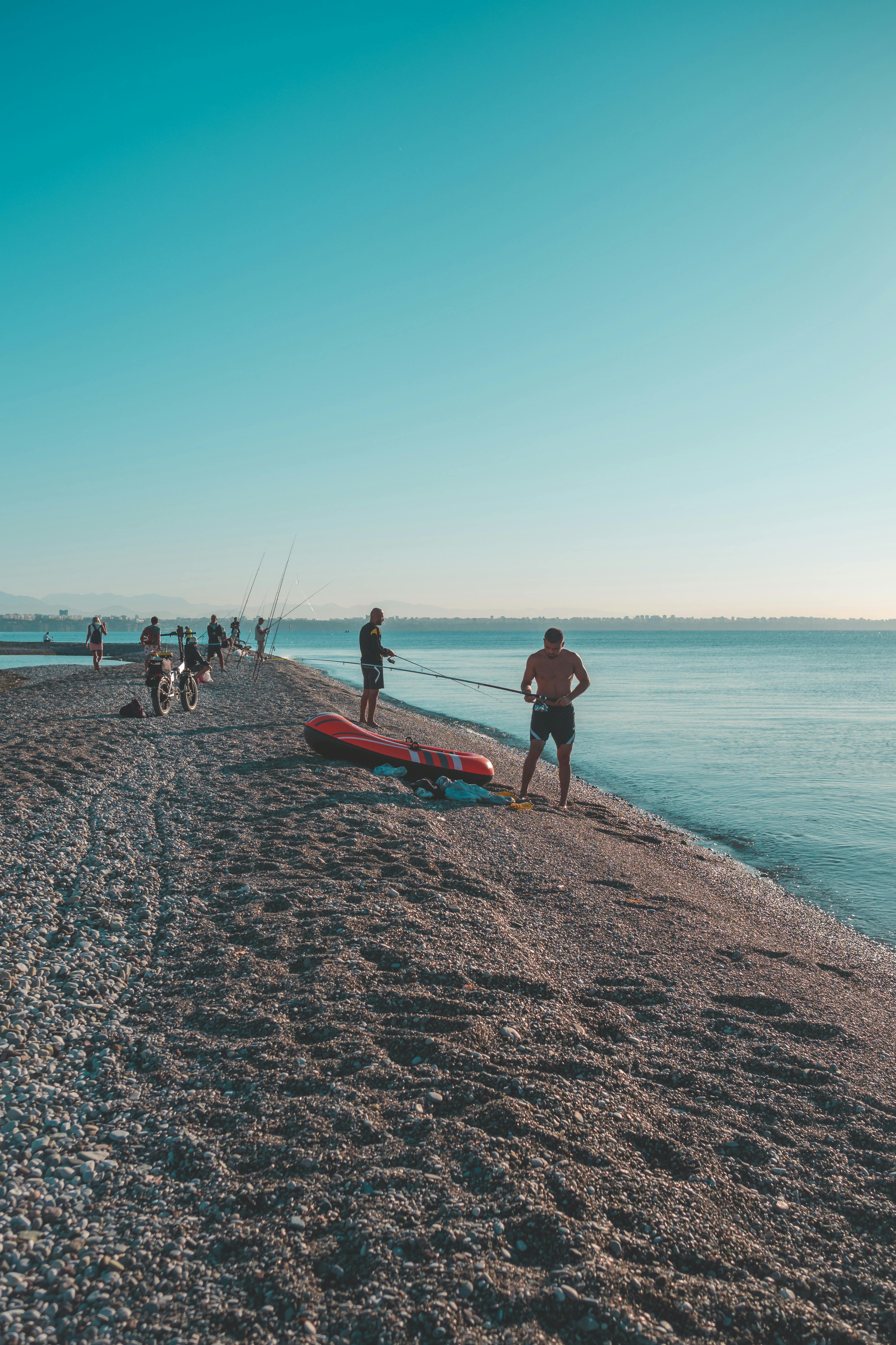 People Fishing on a Beach · Free Stock Photo