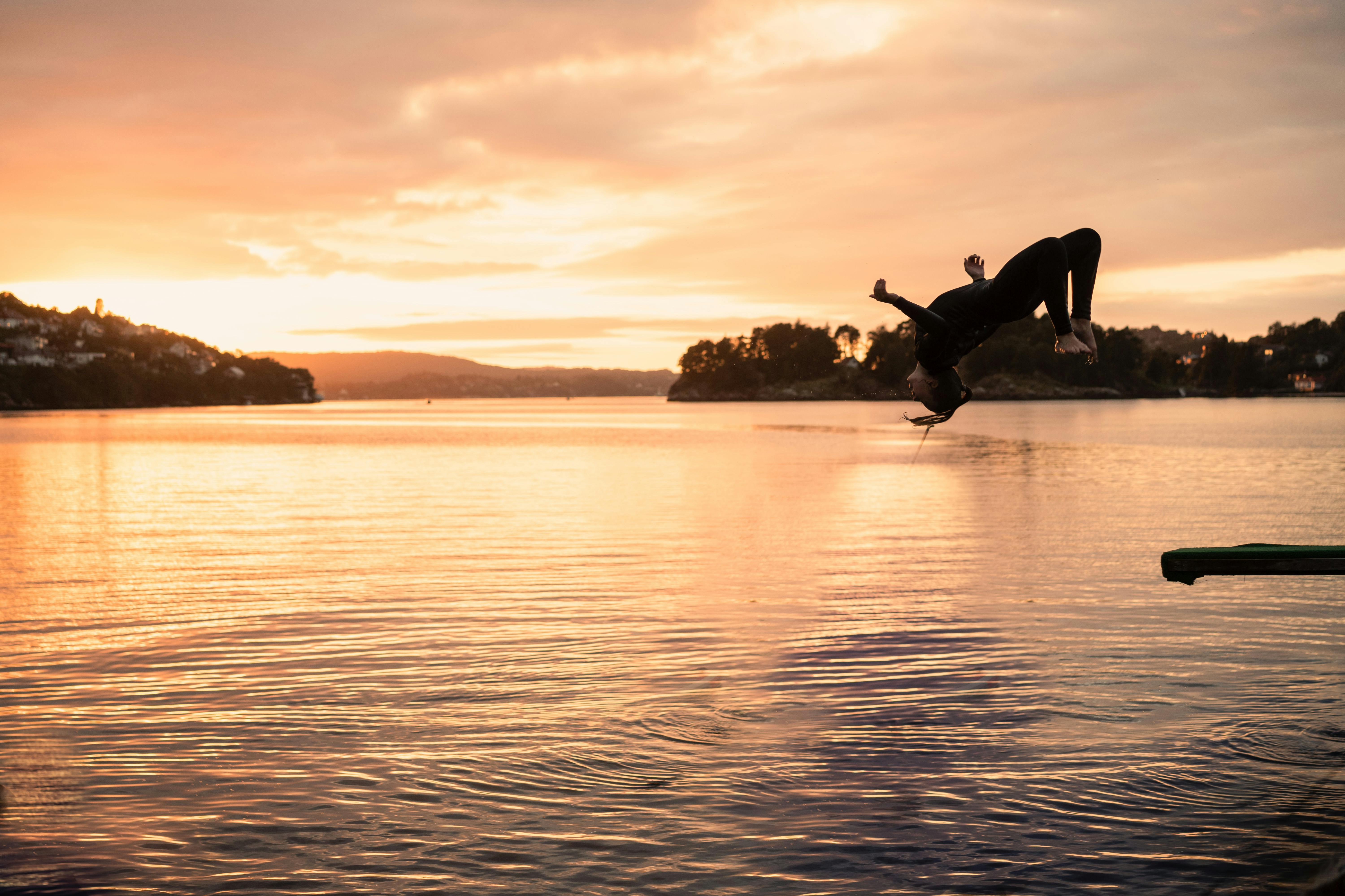 Girl Jumping into Lake · Free Stock Photo