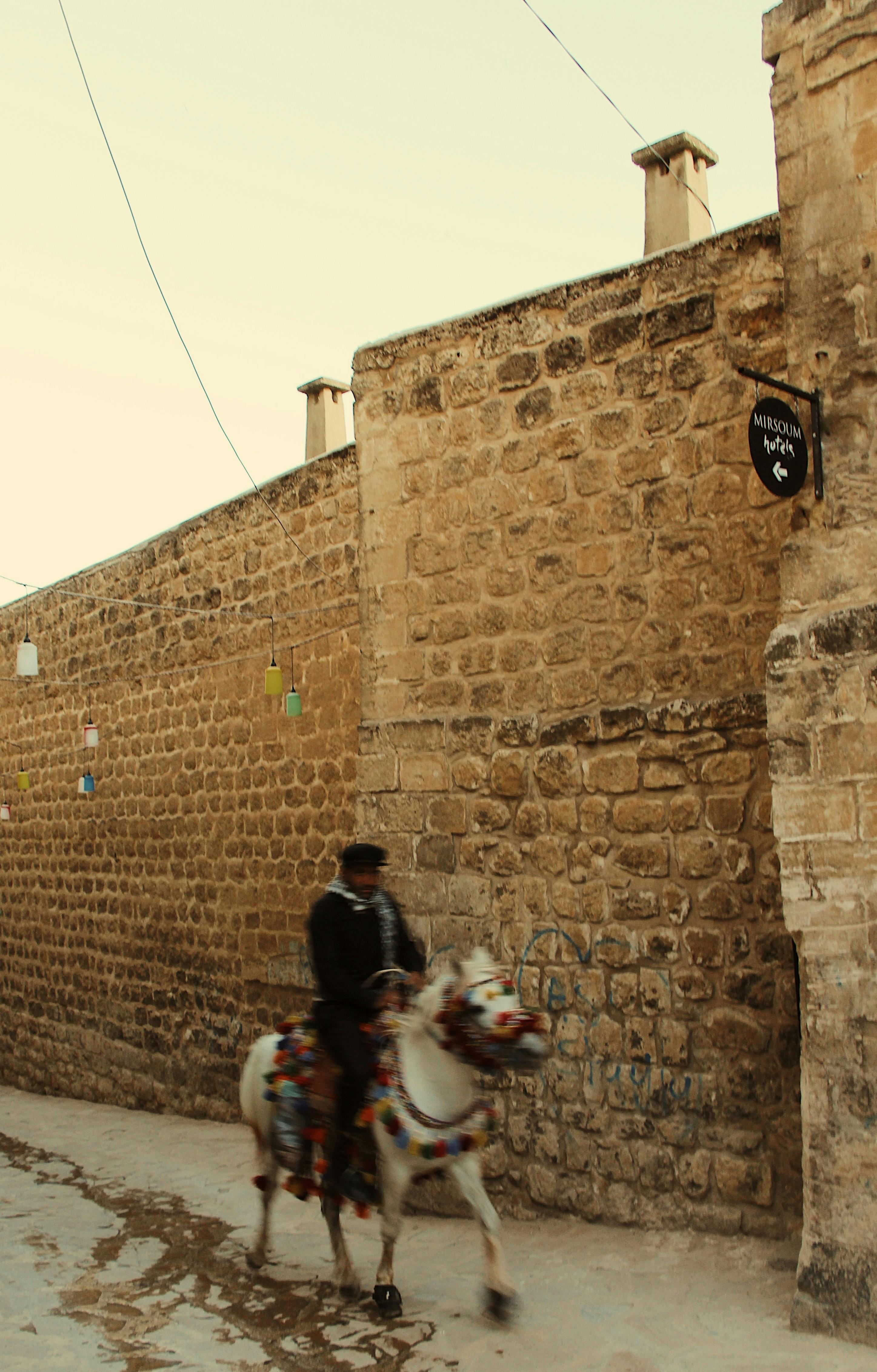 Young Man in Traditional Robe Posing near Old Stone Building · Free ...