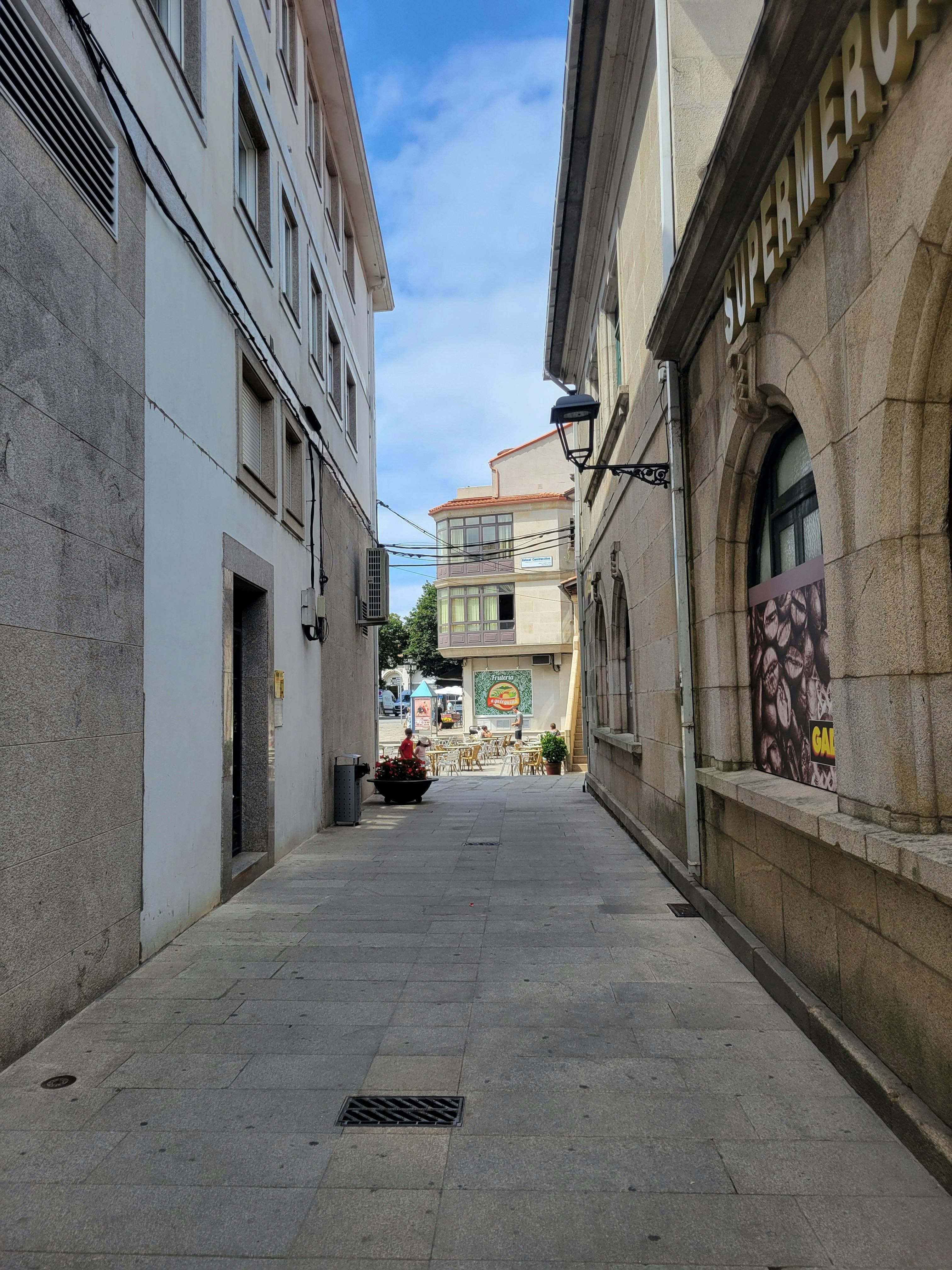 Empty Road Between Concrete Buildings · Free Stock Photo