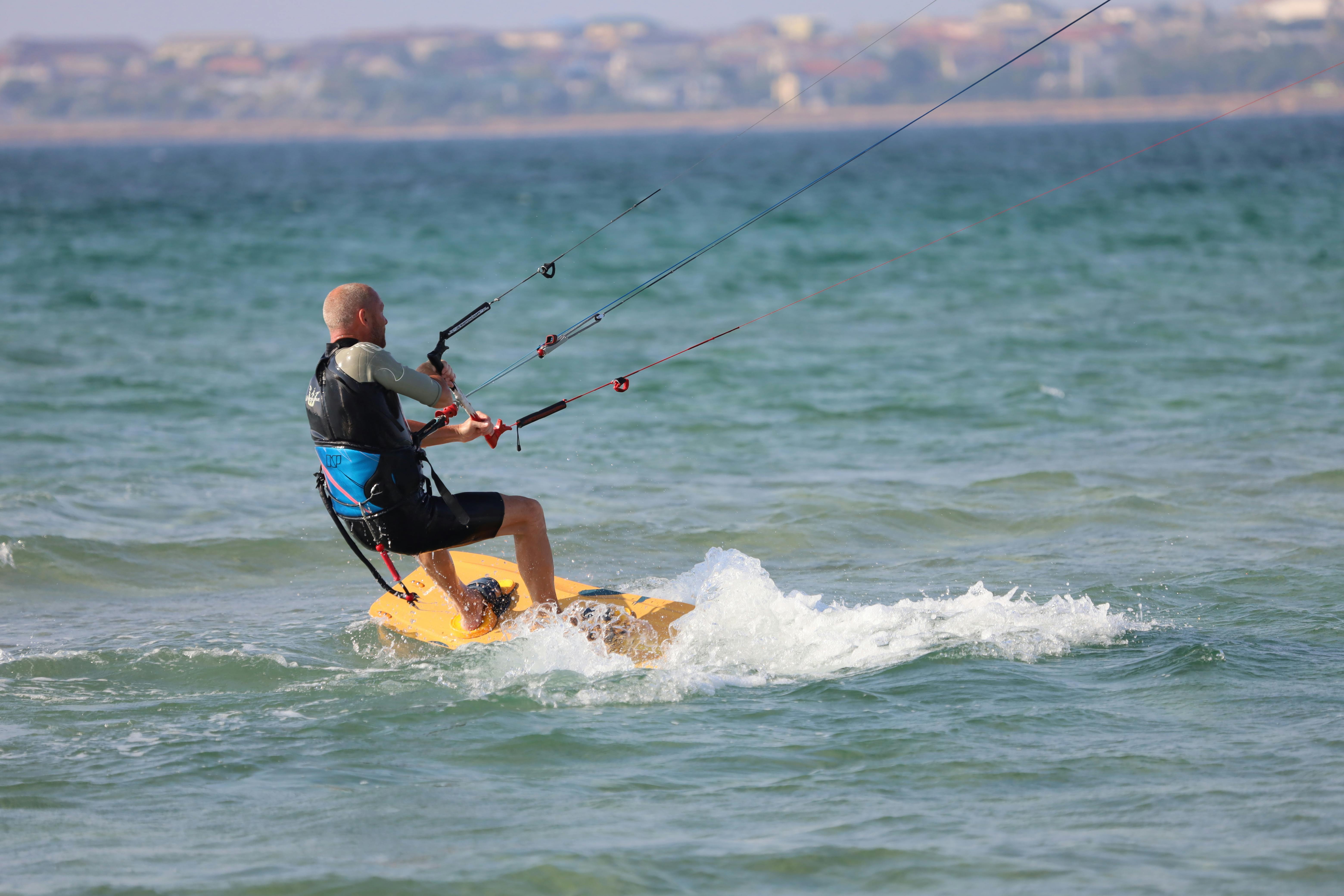 Man while Kitesurfing Showing Shaka · Free Stock Photo
