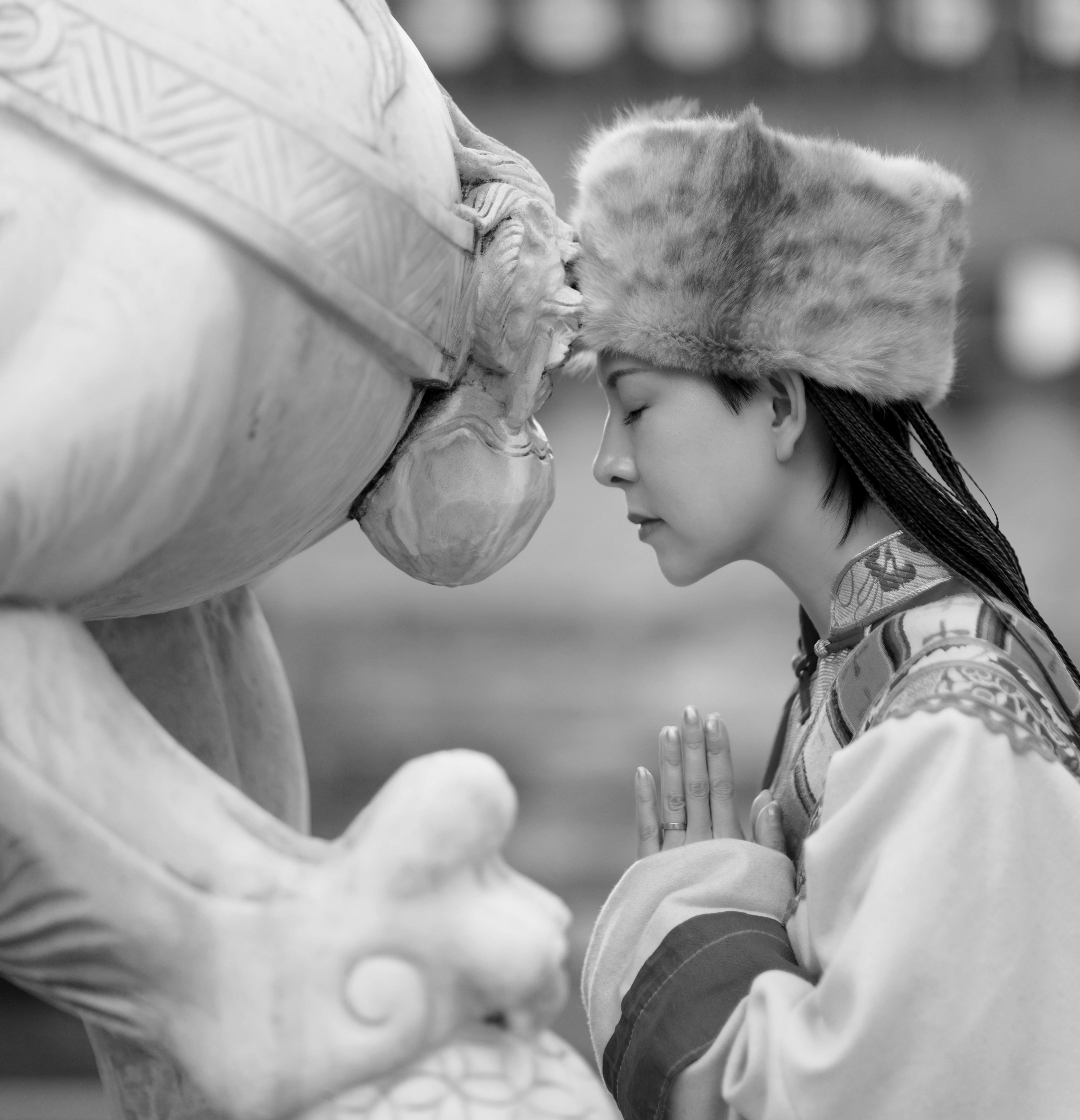 Praying Woman Touching Statue with Forehead · Free Stock Photo