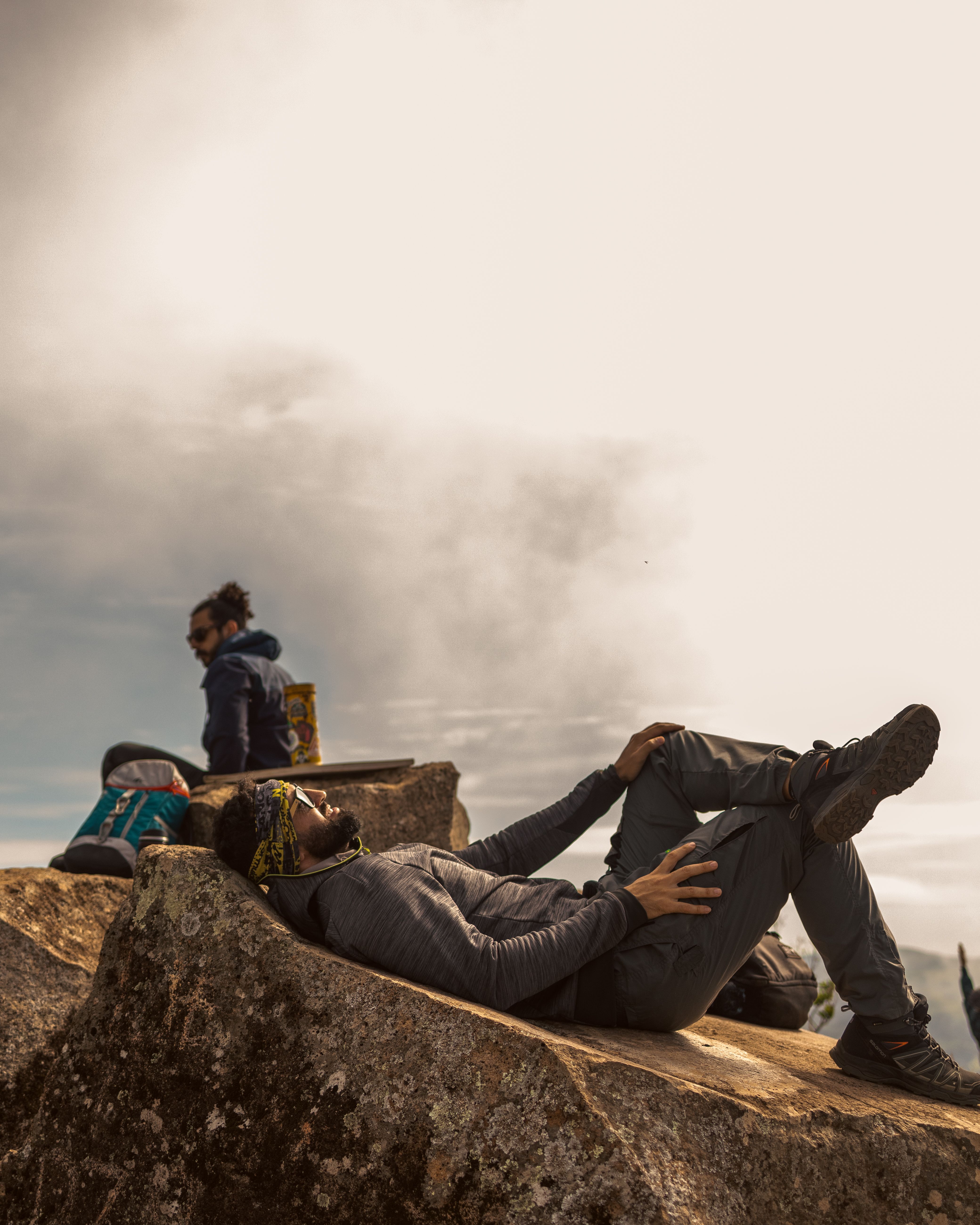 Men Wearing Hoodies Relaxing on Stone Boulder Outdoor Photo · Free ...