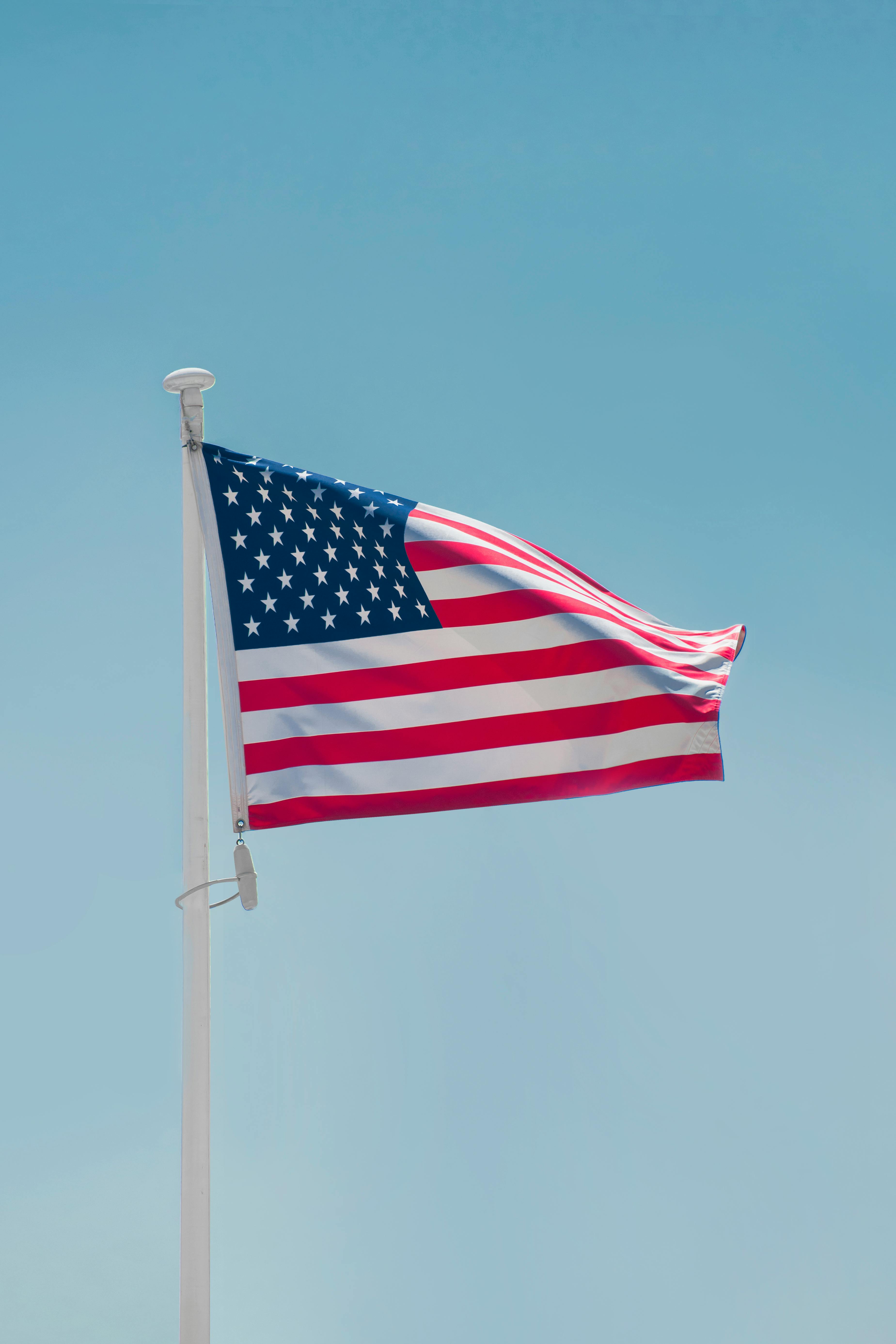 Waving Flag Under the Blue Sky · Free Stock Photo