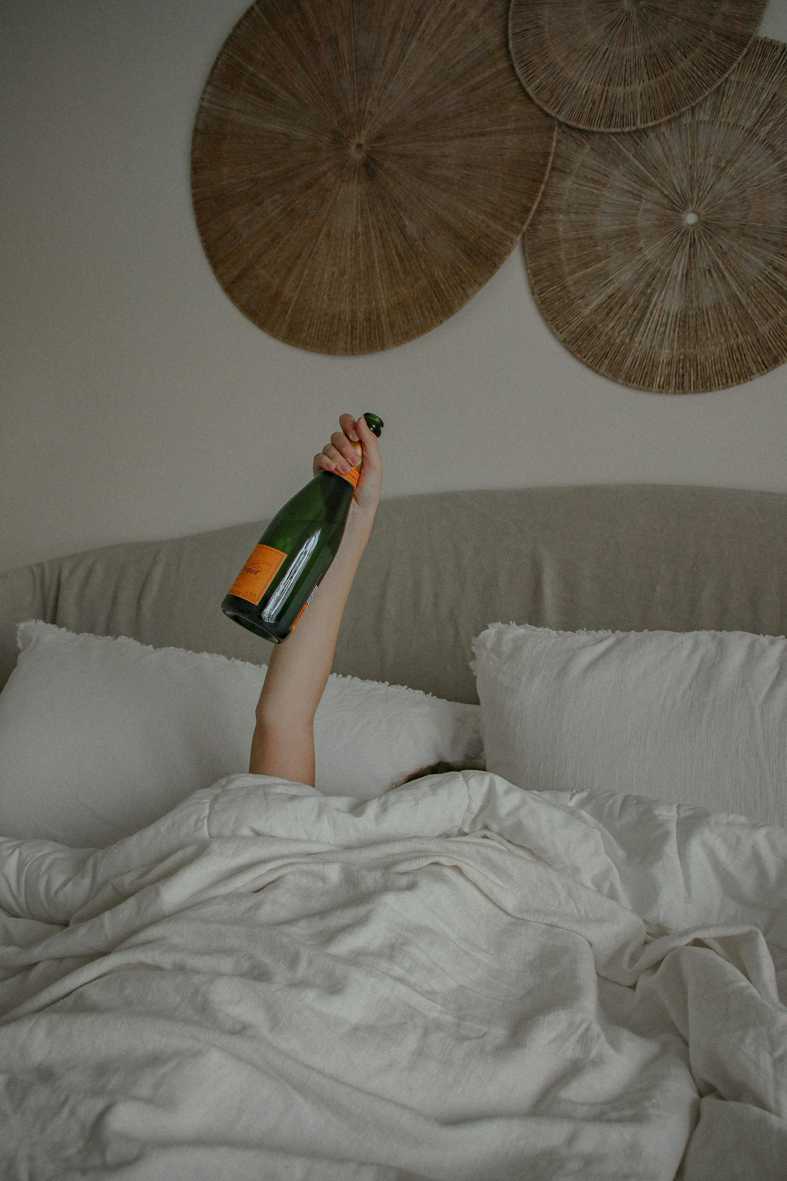 Woman Pouring Champagne in a Bed · Free Stock Photo