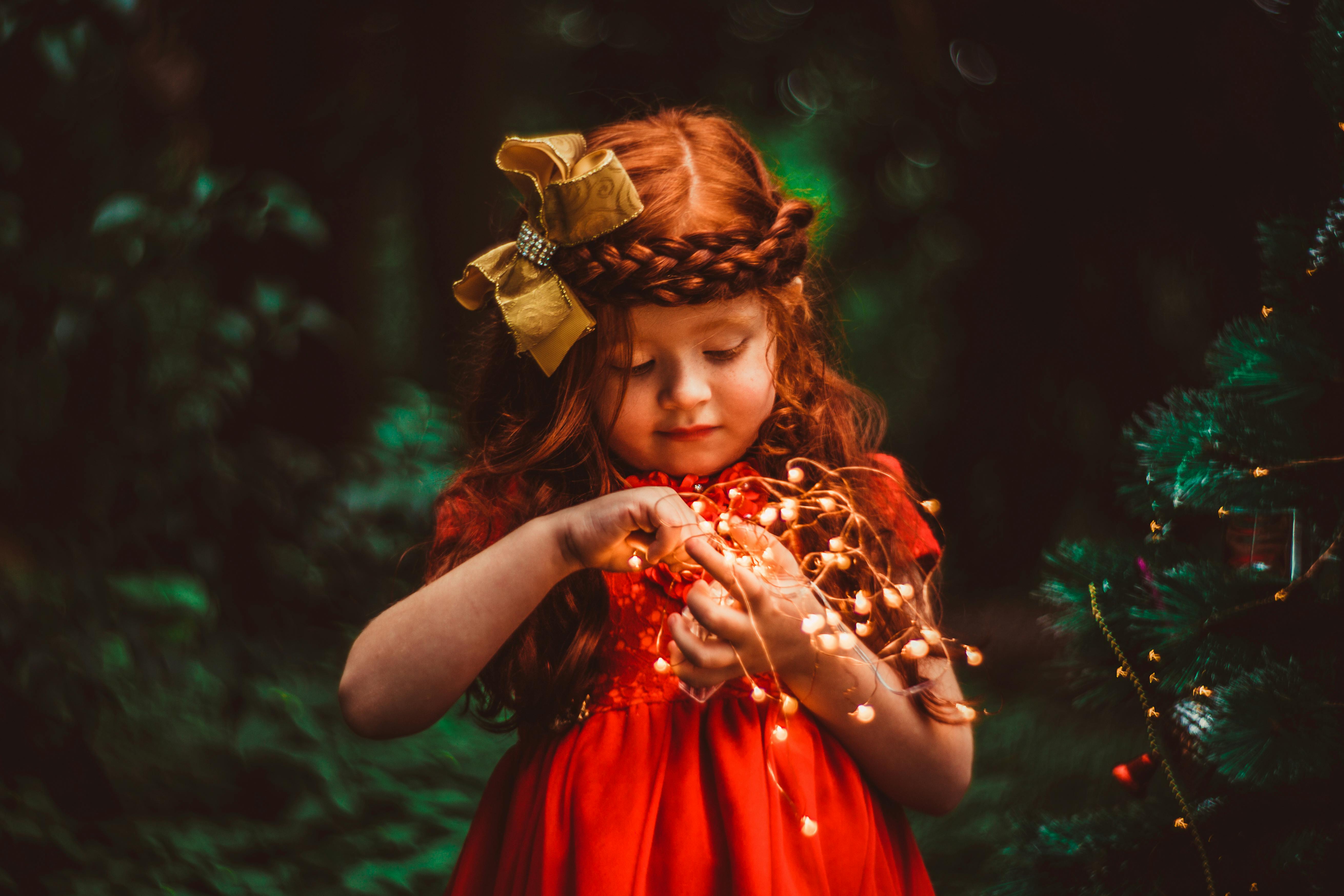 Girl in Red Dress Holding String Lights · Free Stock Photo