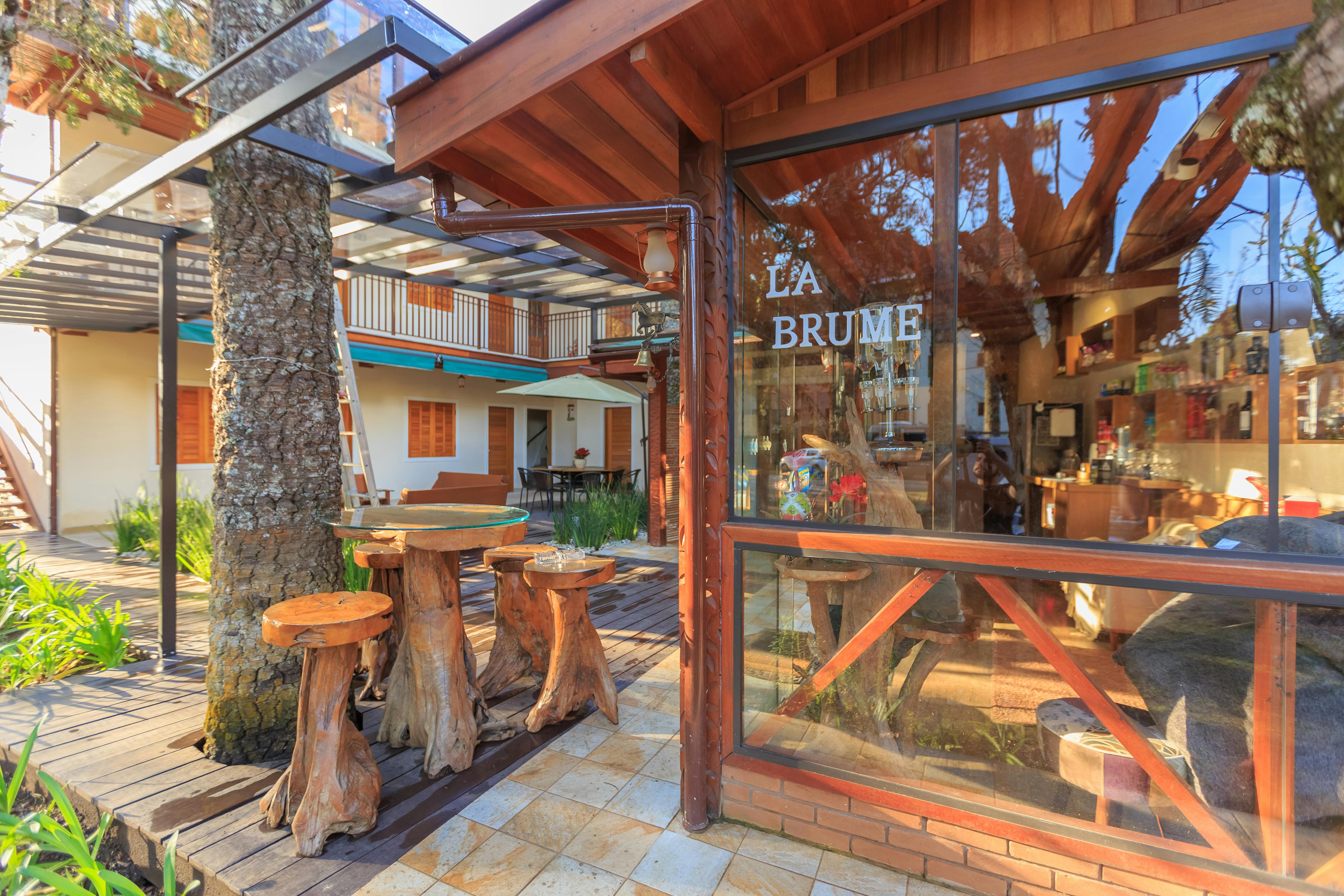 Modern Rustic Cafe and Wooden Seats on a Yard · Free Stock Photo