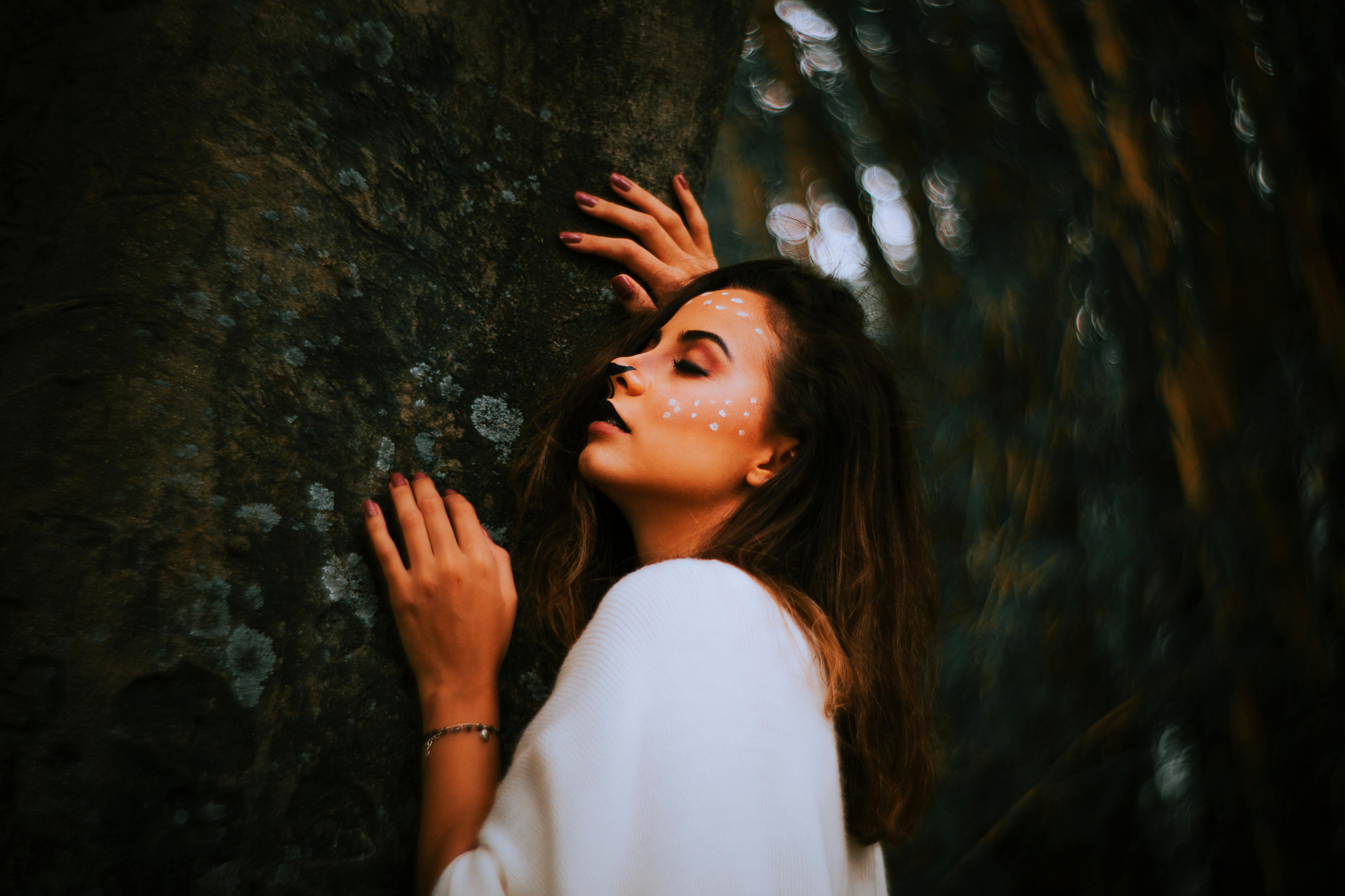 Woman in White Long Sleeve Shirt Leaning on Brown Tree Trunk · Free ...