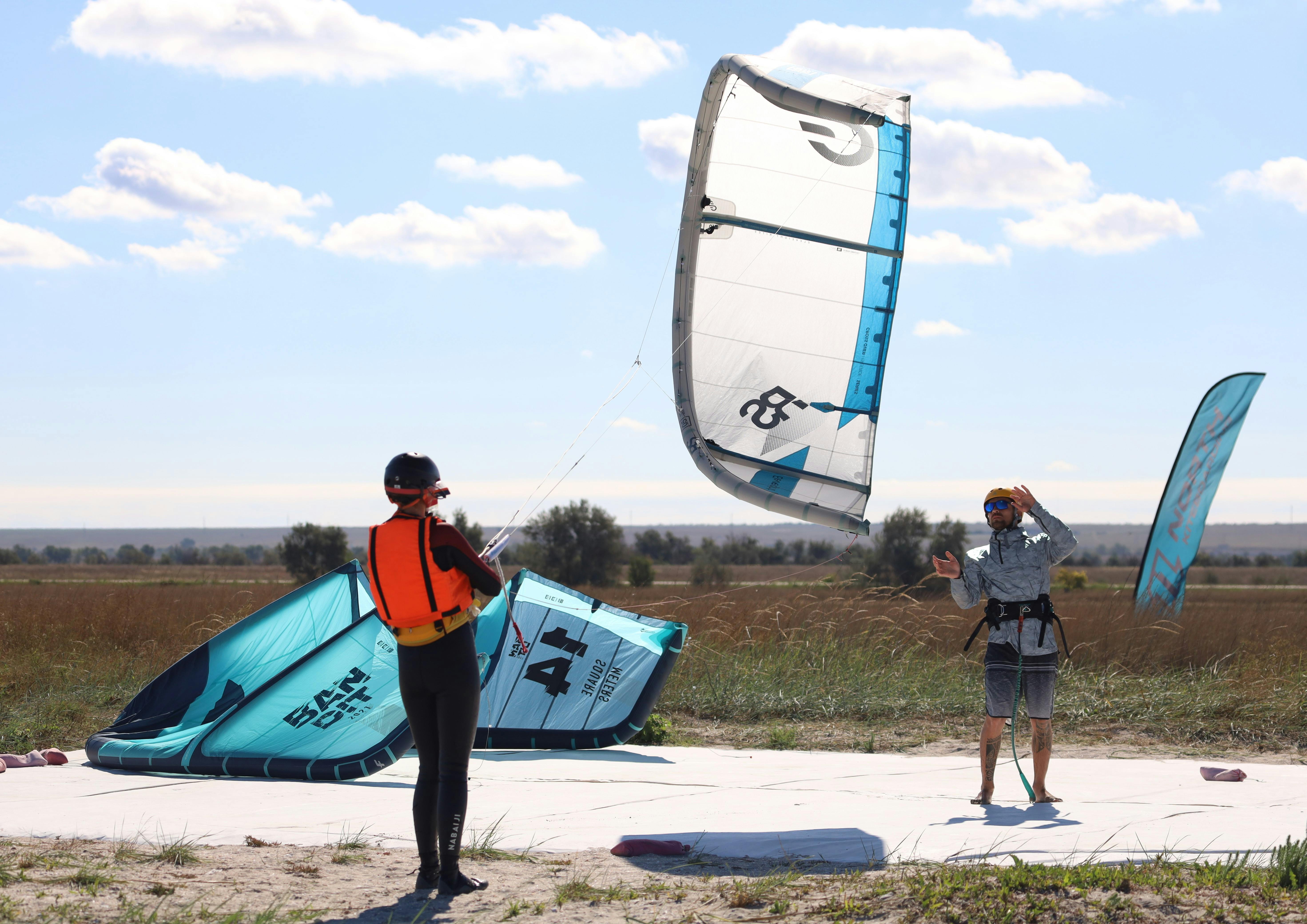 Kitesurfers Standing on Lands with Their Kites · Free Stock Photo
