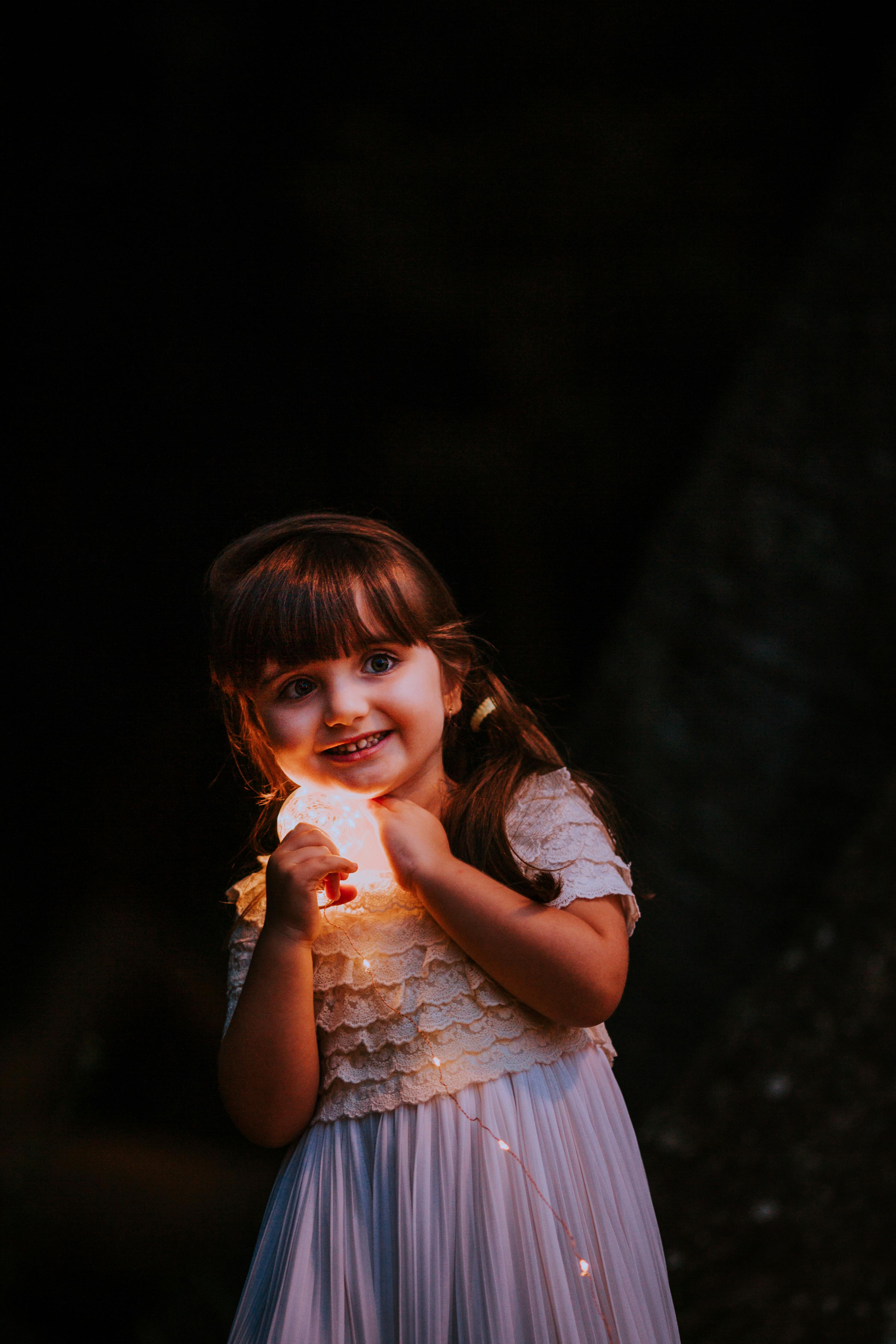 Cute Girl Holding String Lights · Free Stock Photo