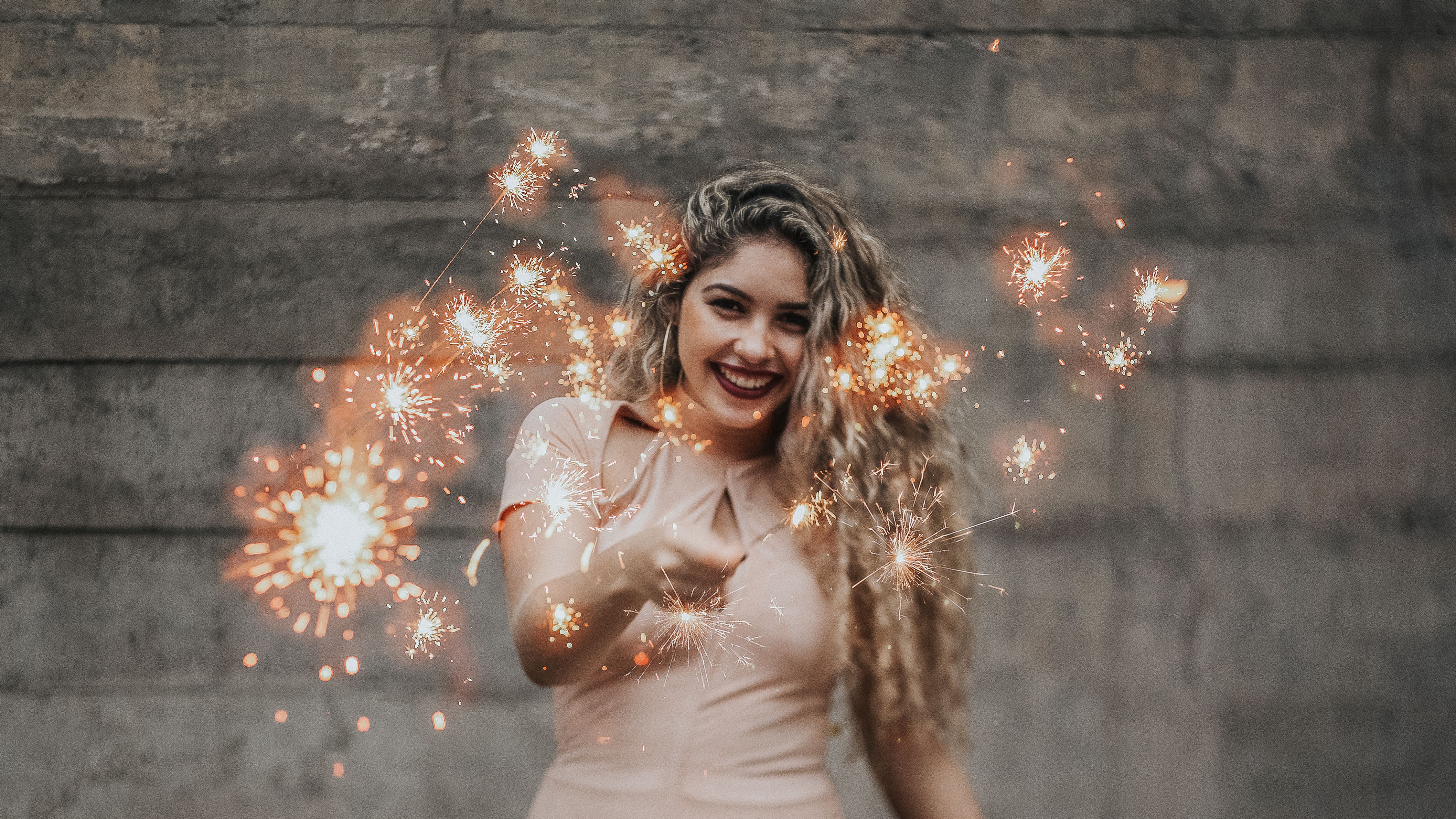 Smiling Woman Holding Sparklers · Free Stock Photo