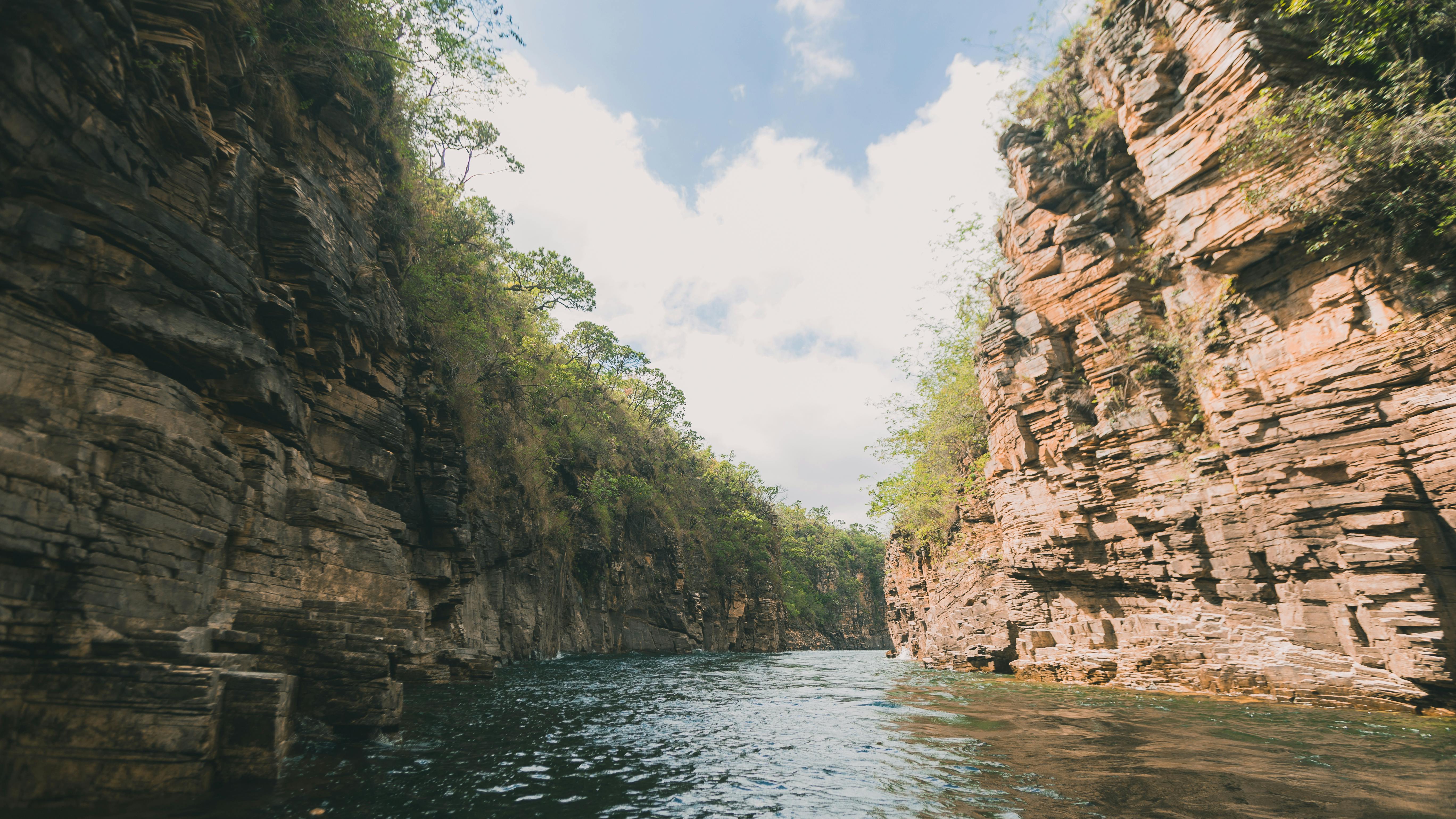 A River in Between the Brown Rock Formations · Free Stock Photo
