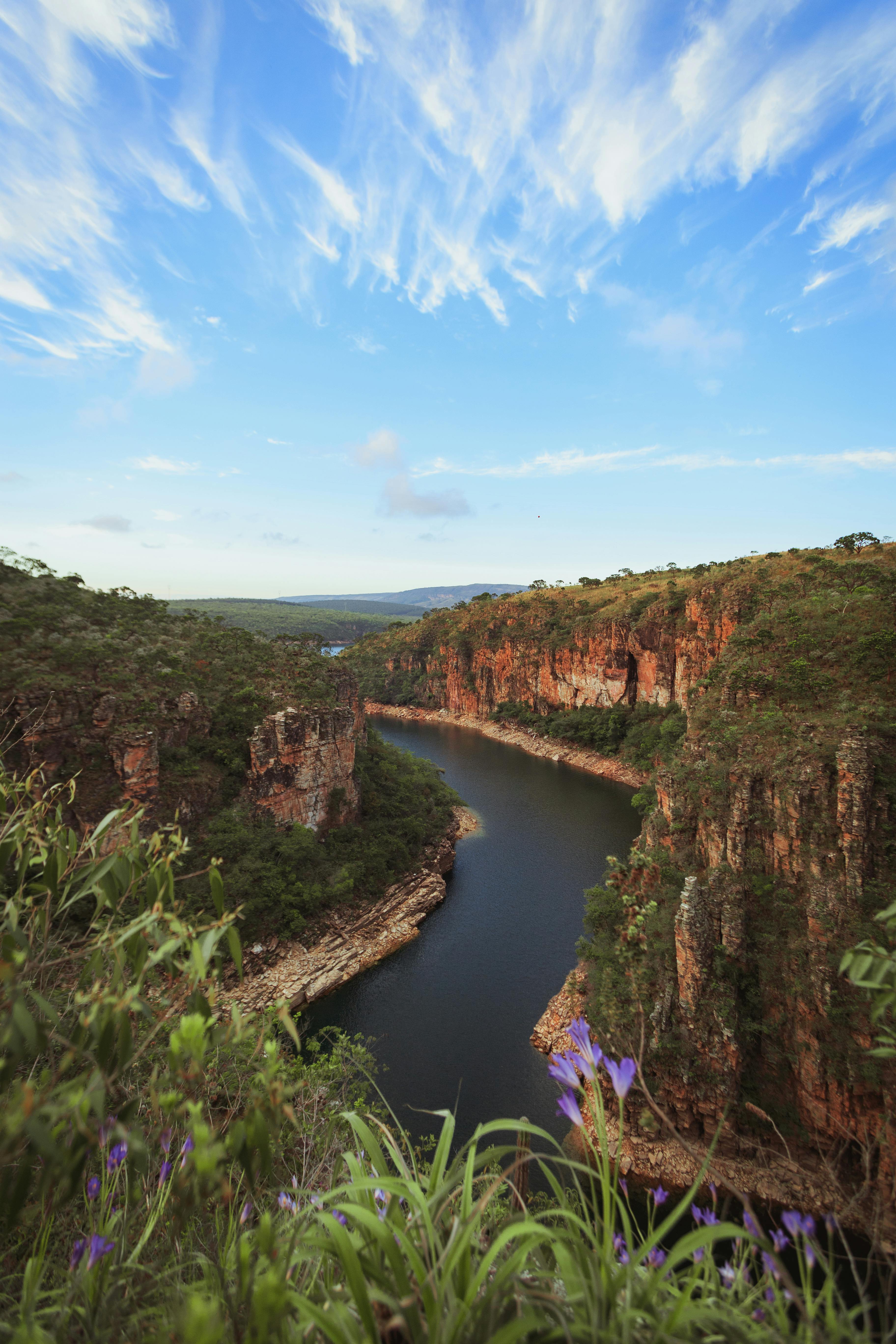 Blue Sky and Clouds above a Narrow Lake · Free Stock Photo