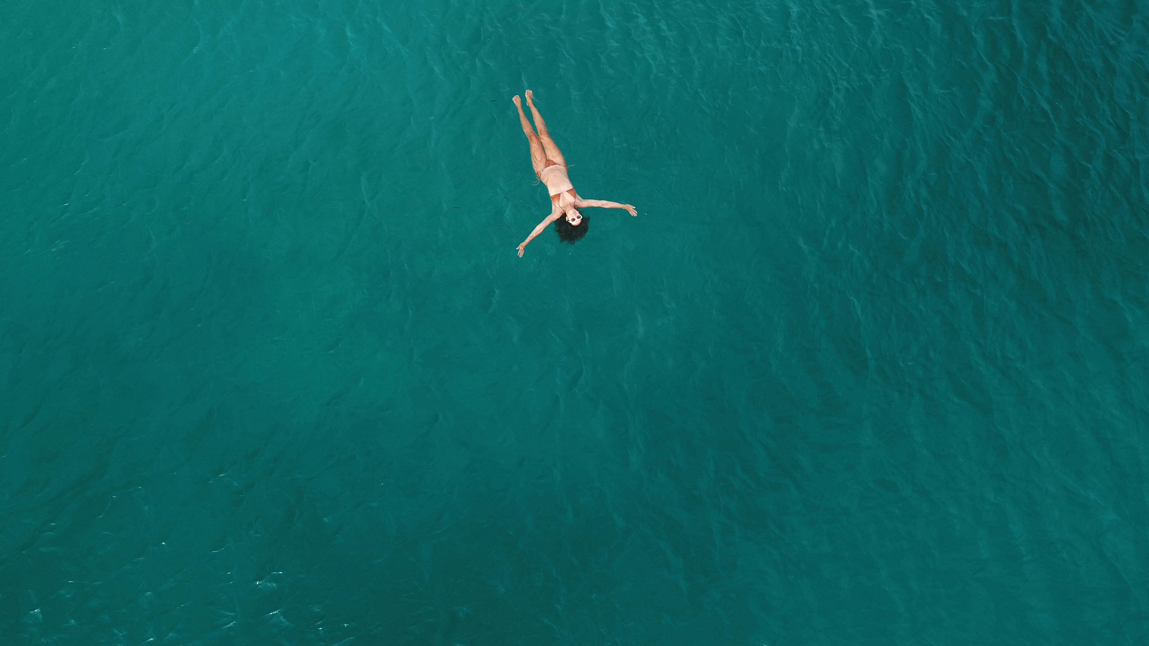 Top View of Woman Floating on the Sea Surface · Free Stock Photo