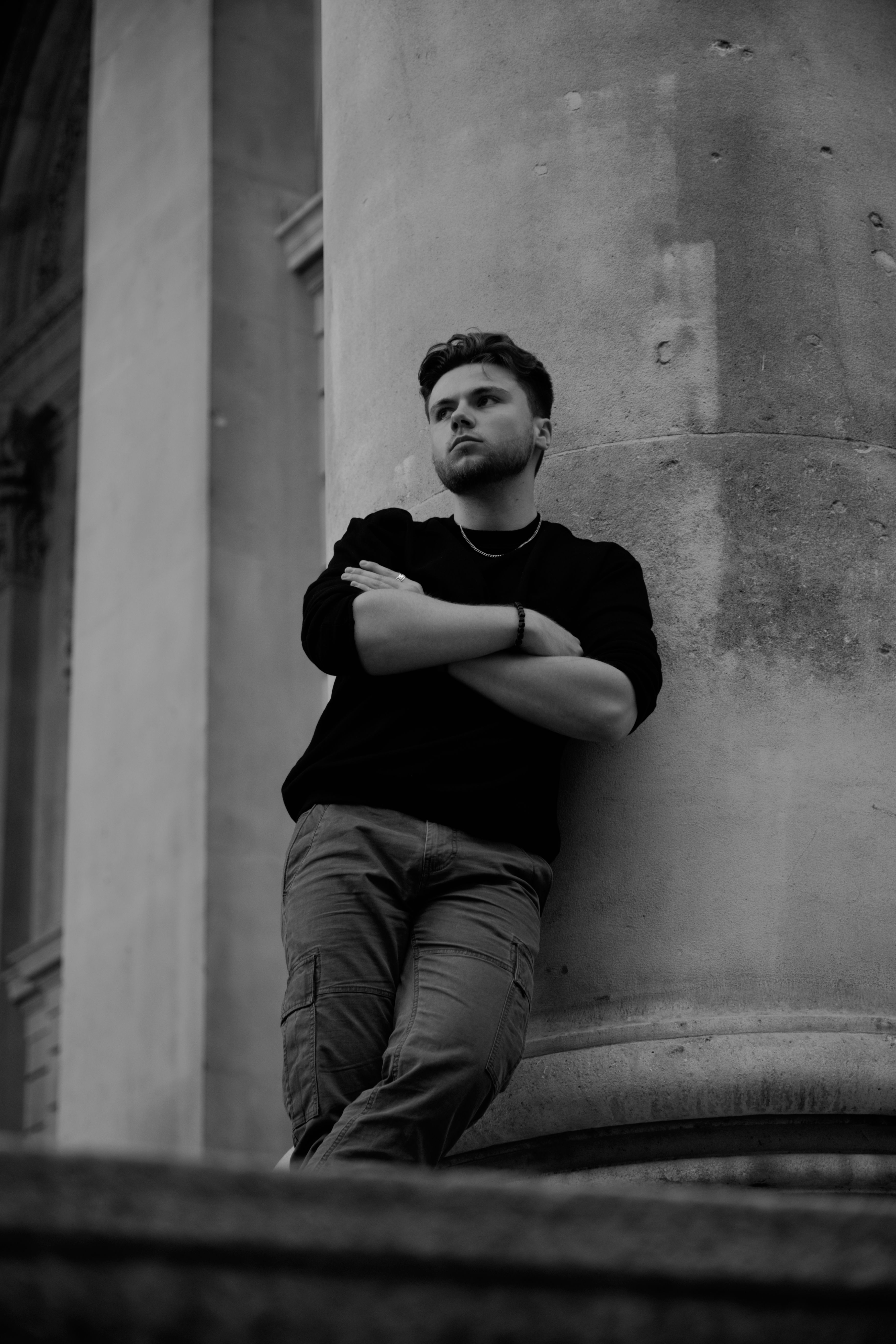 Man Posing near Column Outdoors · Free Stock Photo
