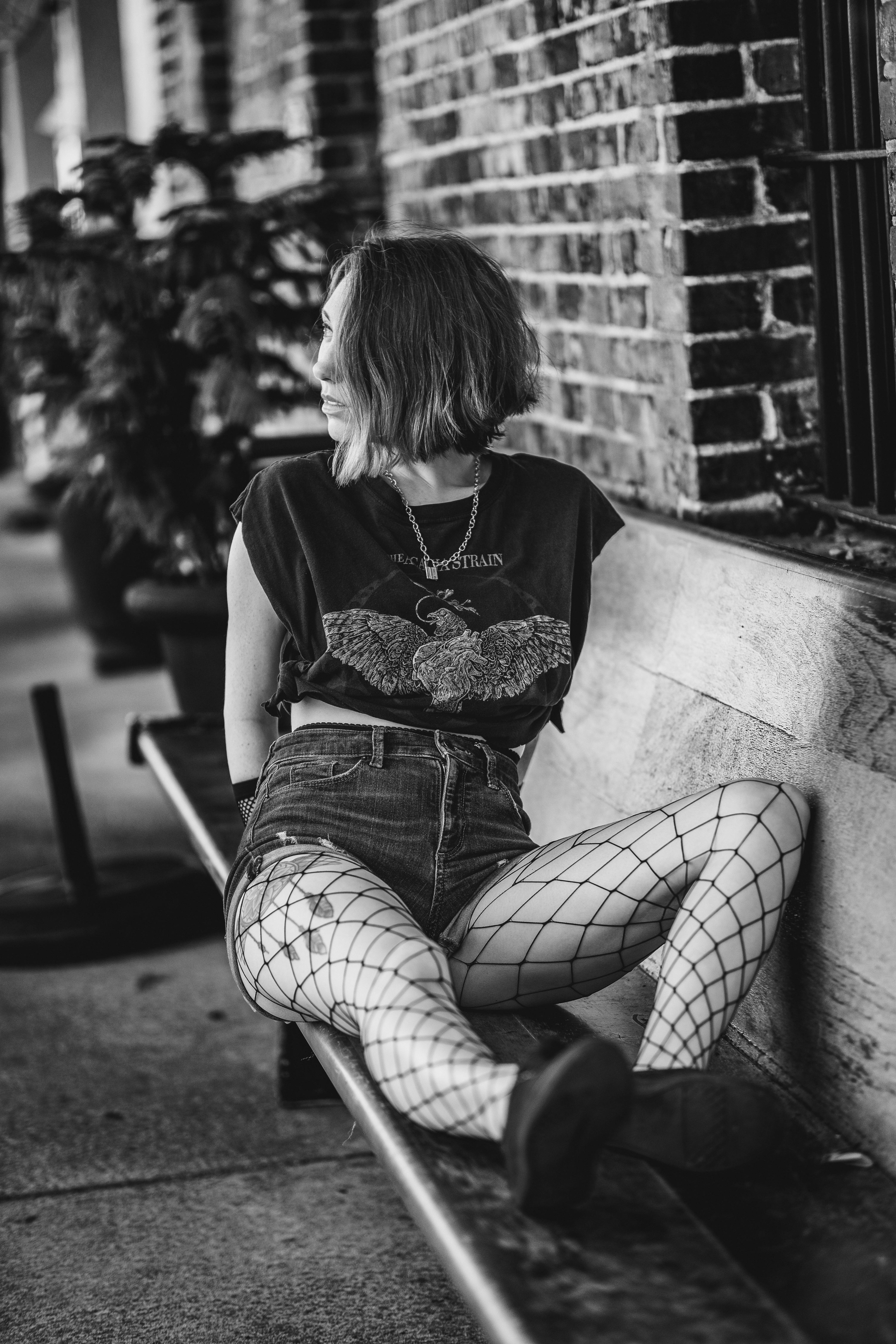 Woman Wearing Fishnet Stockings Sitting on a Bench · Free Stock Photo