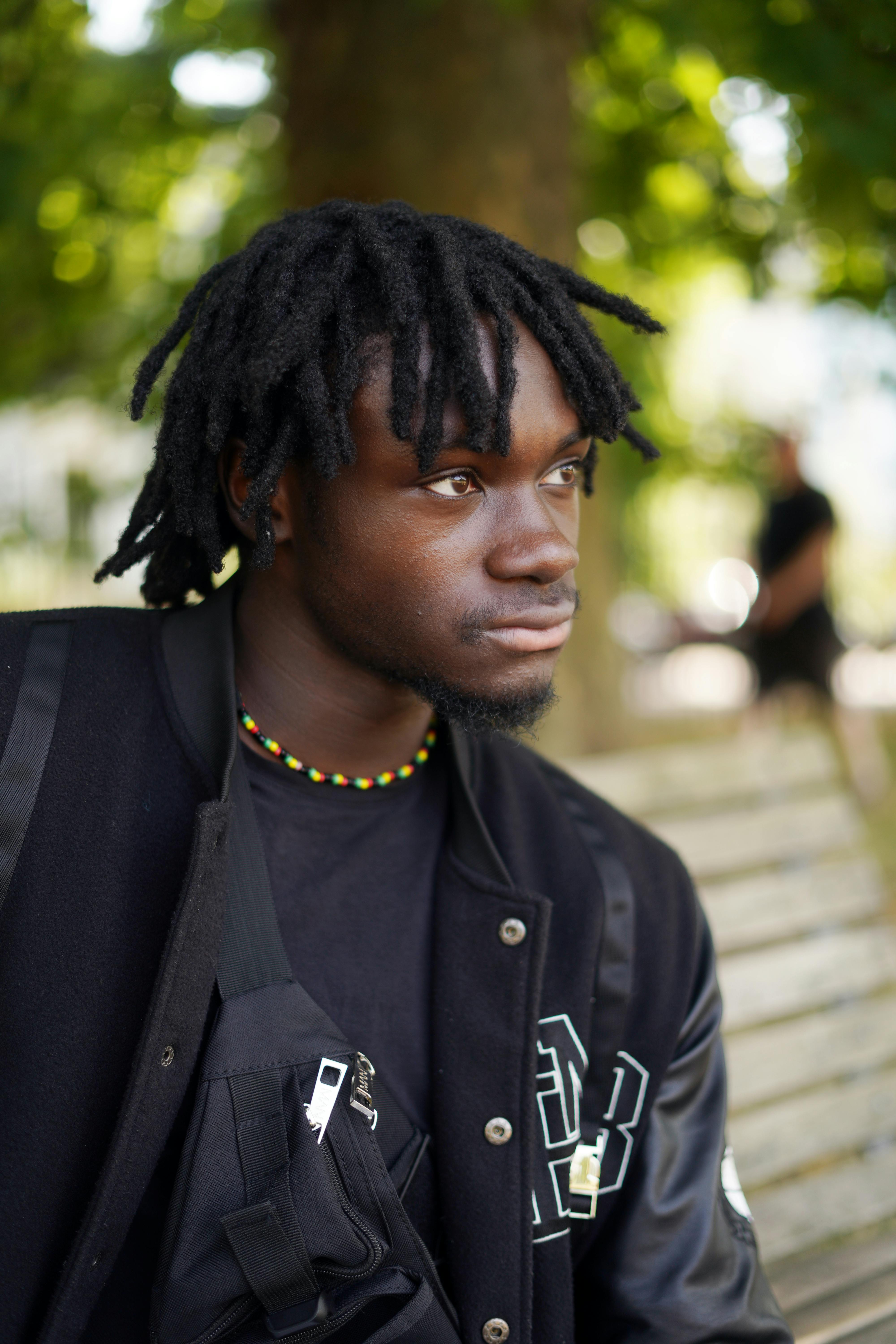 A Sad Man Wearing Neon Green Jacket while Looking Afar · Free Stock Photo