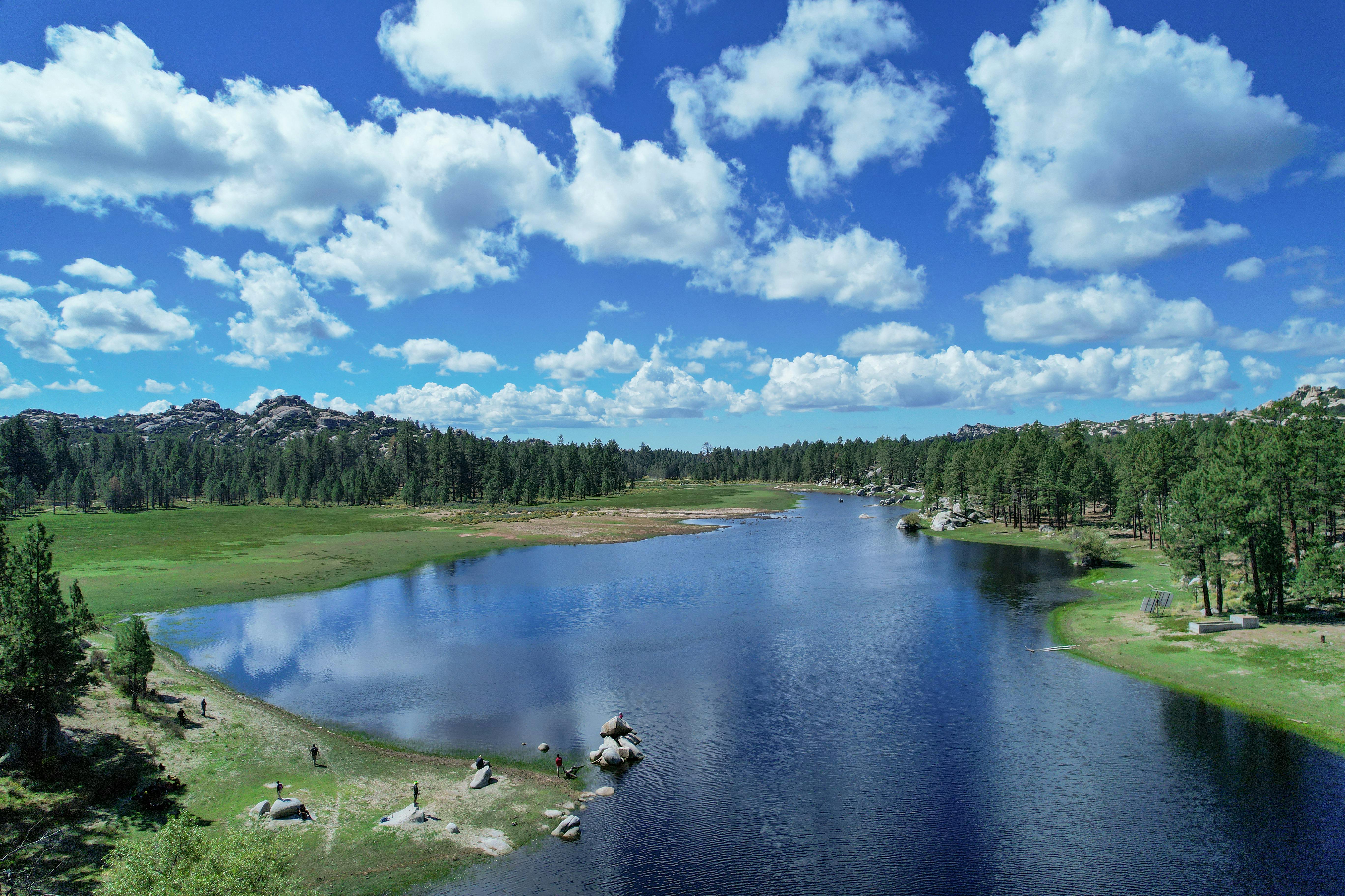 Scenic View of Lake Against Cloudy Sky · Free Stock Photo