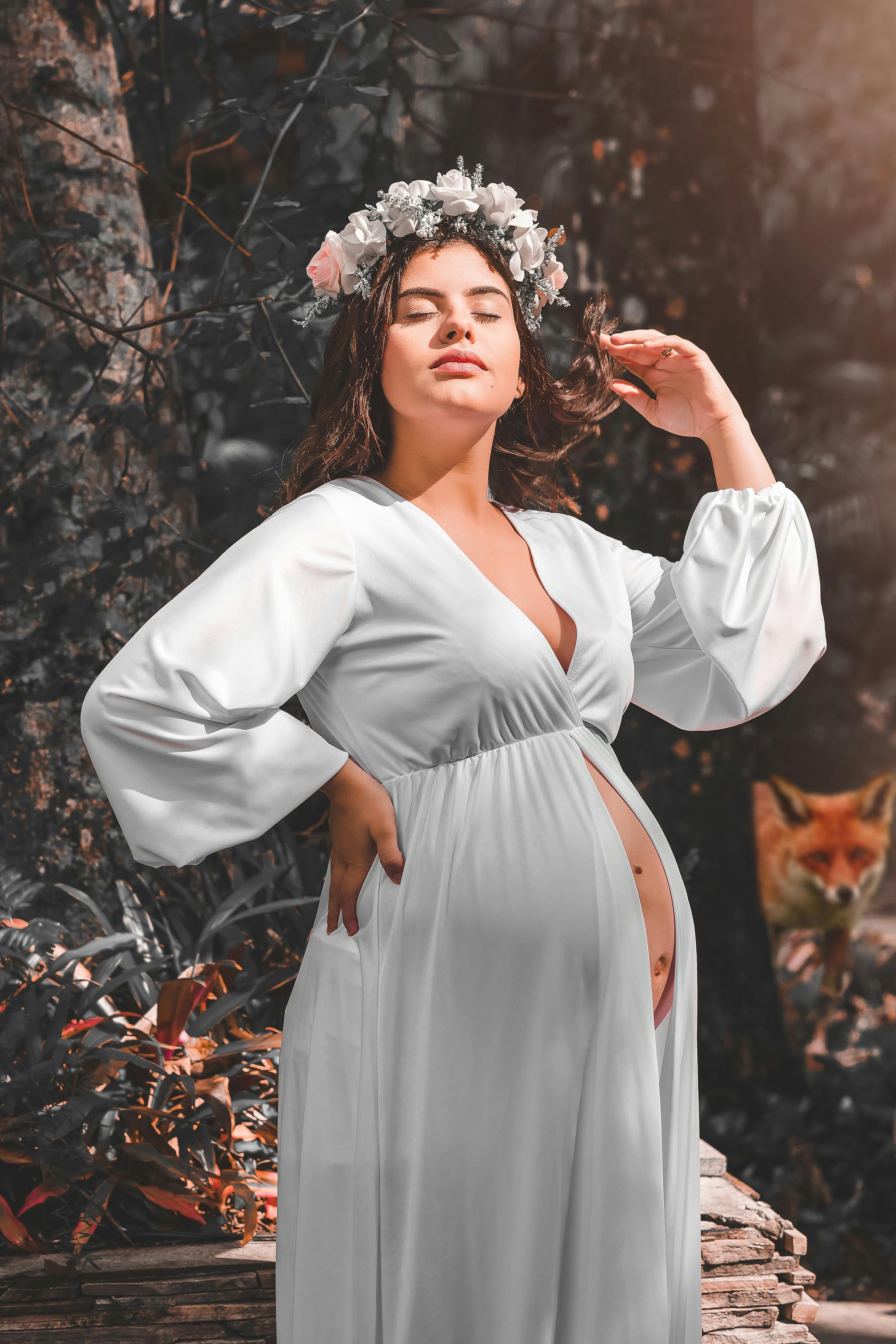 Photo of Woman in White Dress Posing with Her Head up and Her Hands ...