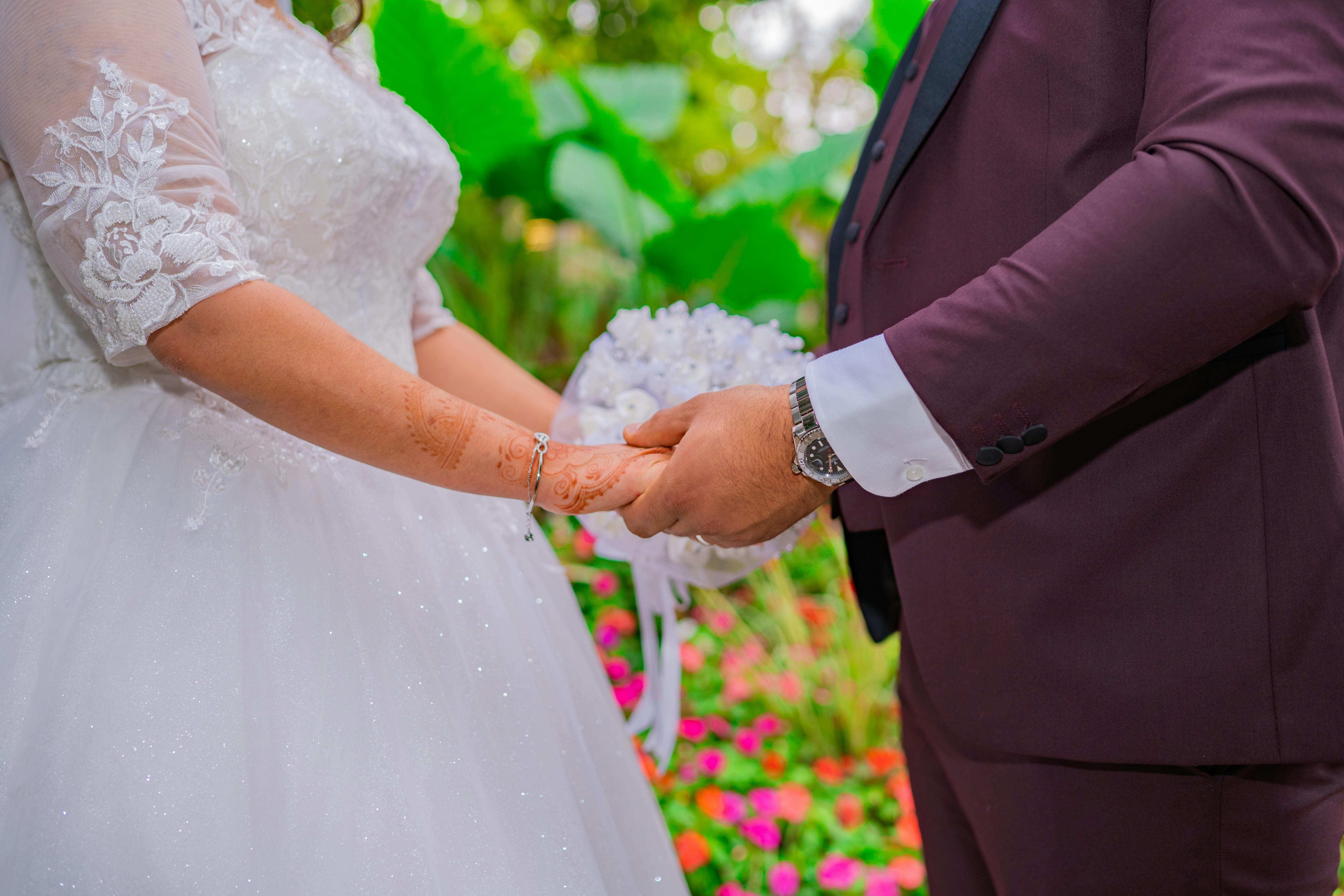Couple's Hands Together During Wedding · Free Stock Photo