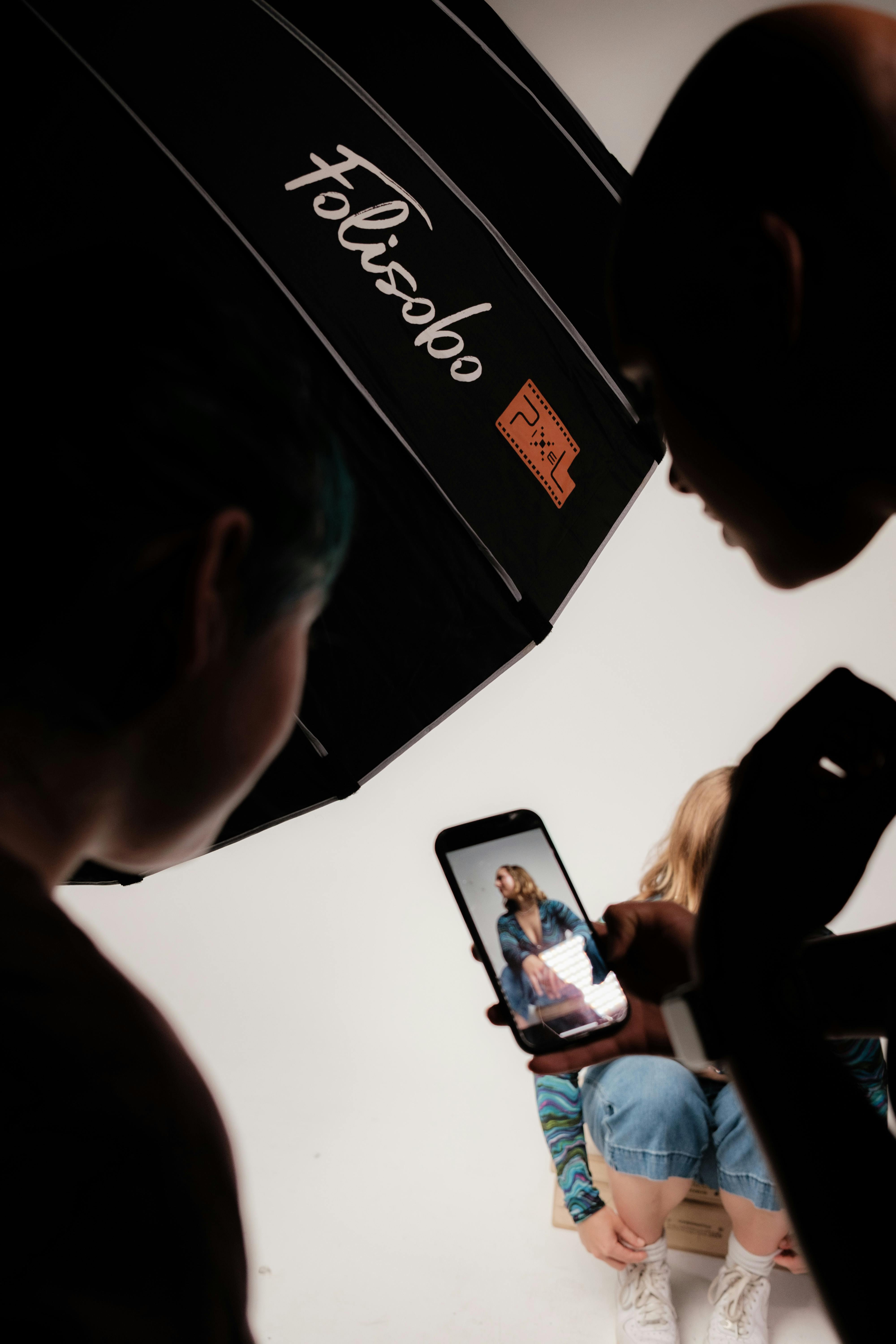 Photographers Talking Photo of Model in Studio · Free Stock Photo