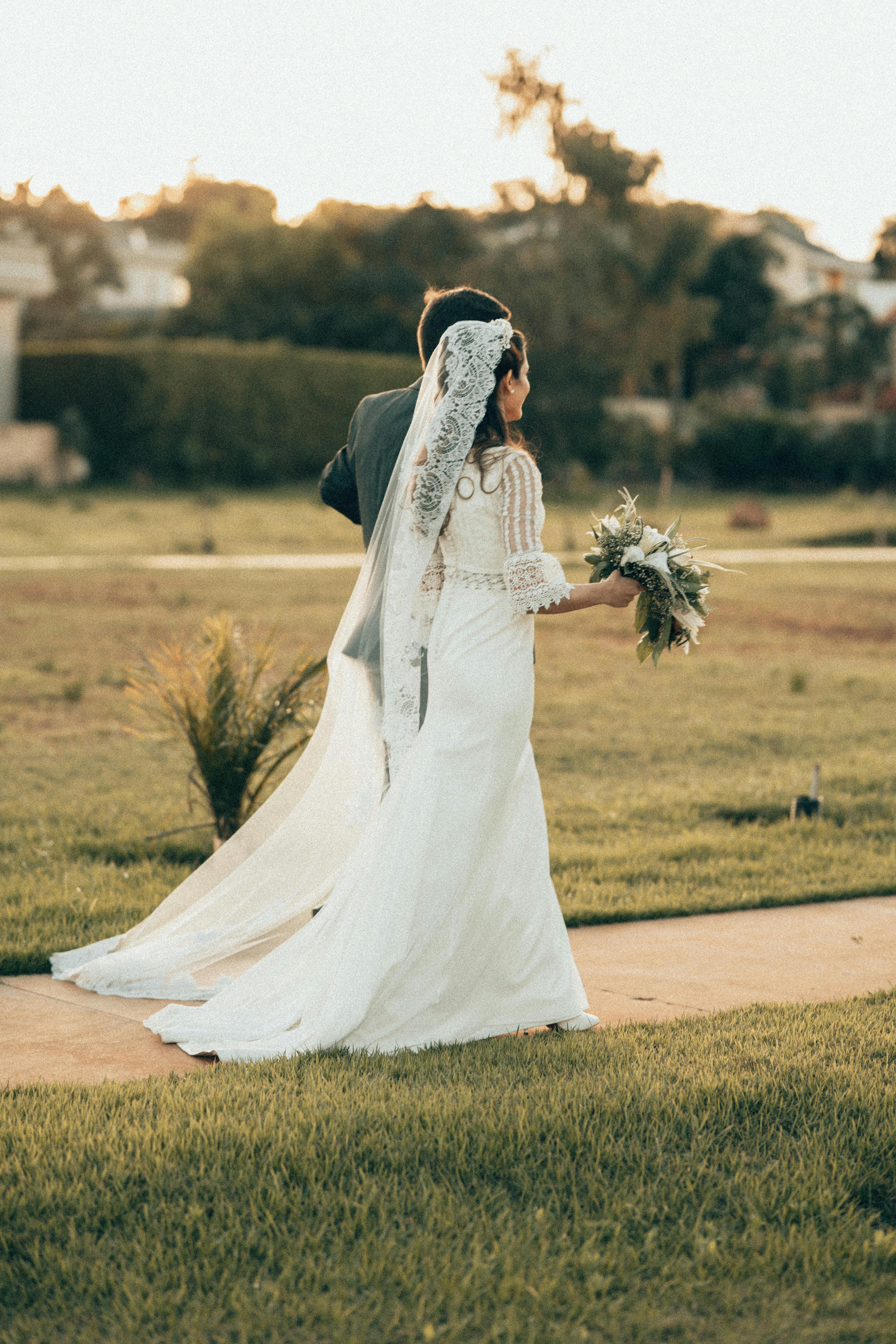 Bride and Groom Walking in Garden · Free Stock Photo