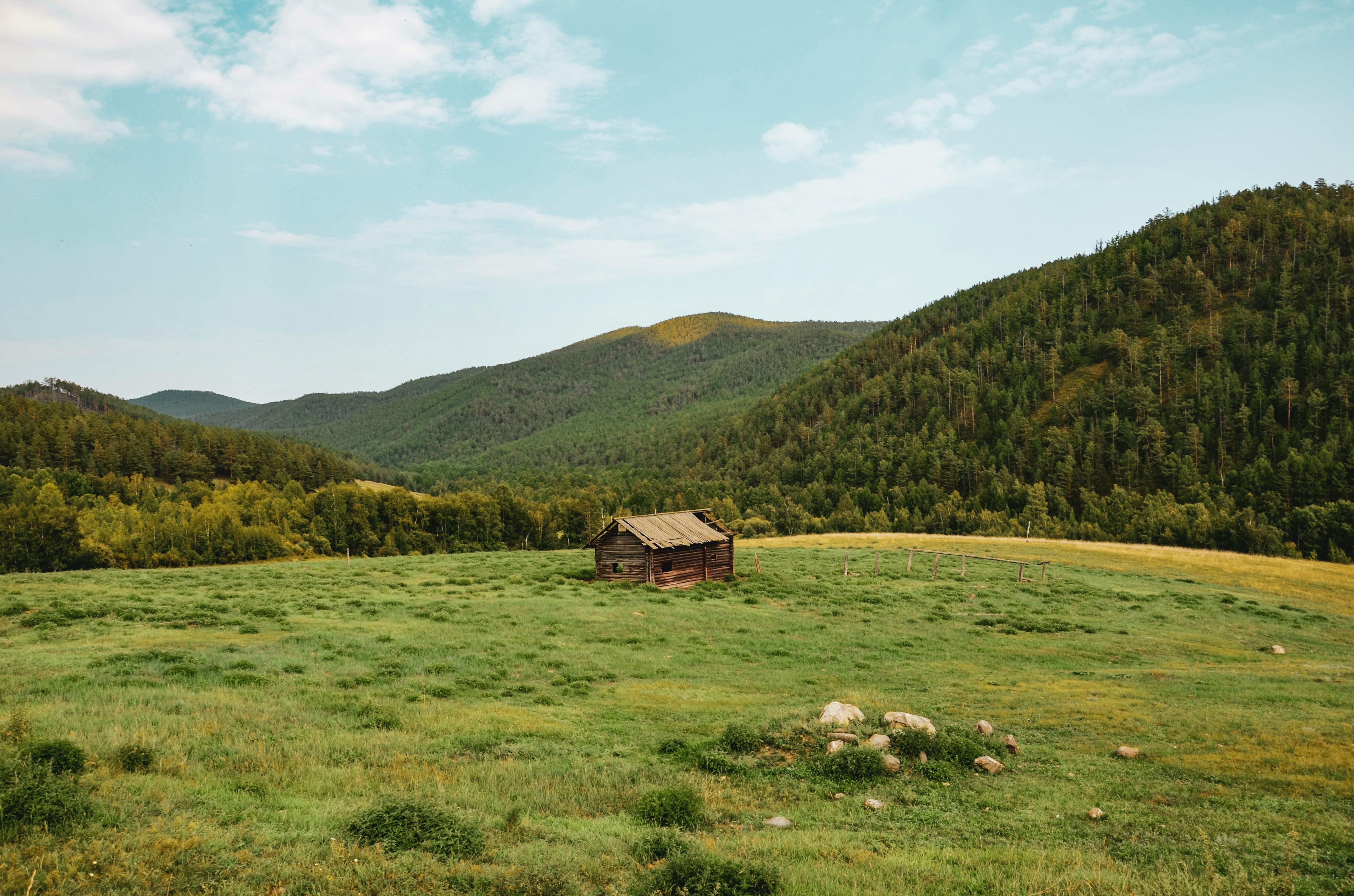 Wooden Hut on a Hill Surrounded by Forests · Free Stock Photo