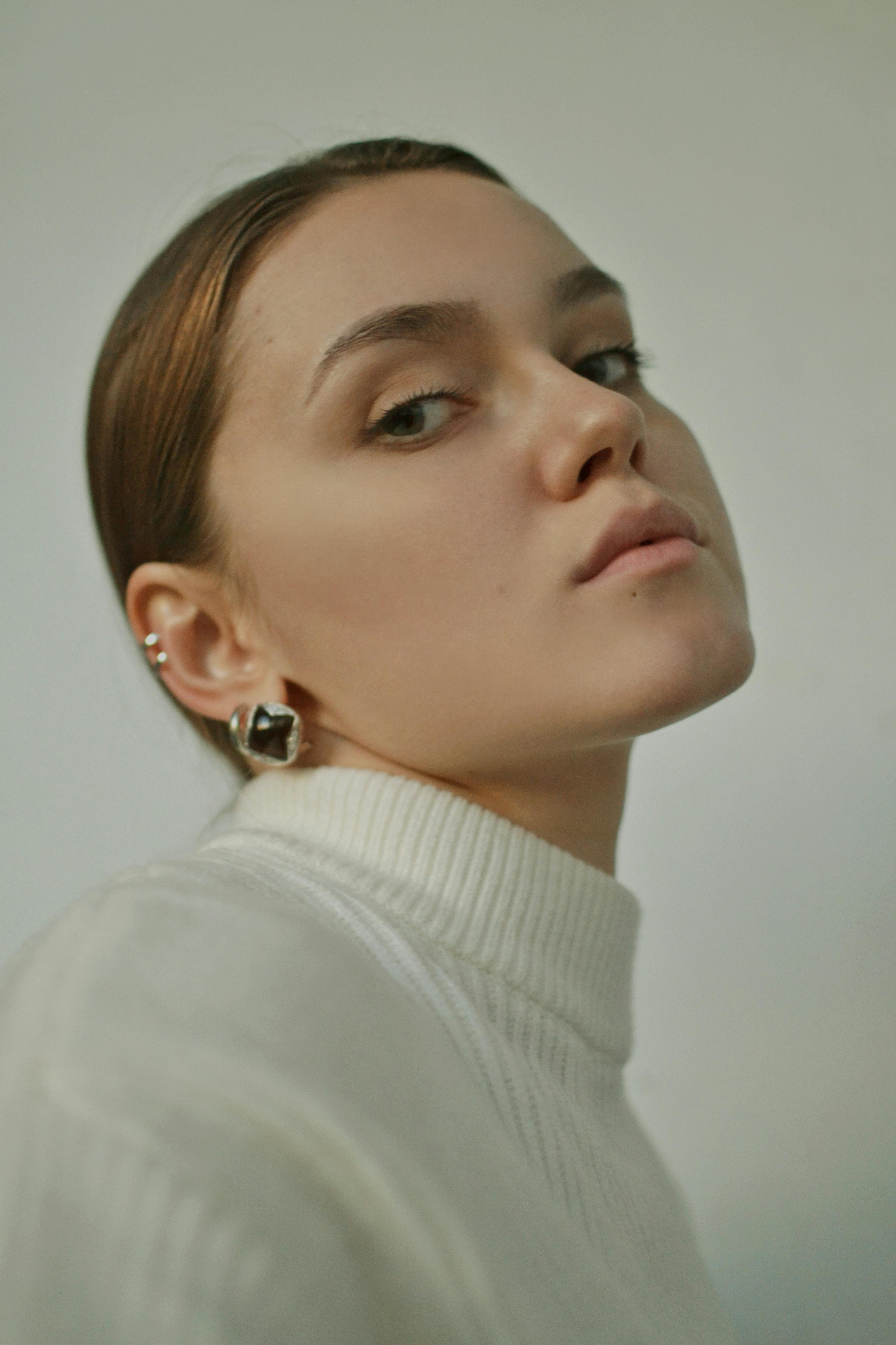 Woman in Shadow Posing on Studio Background · Free Stock Photo