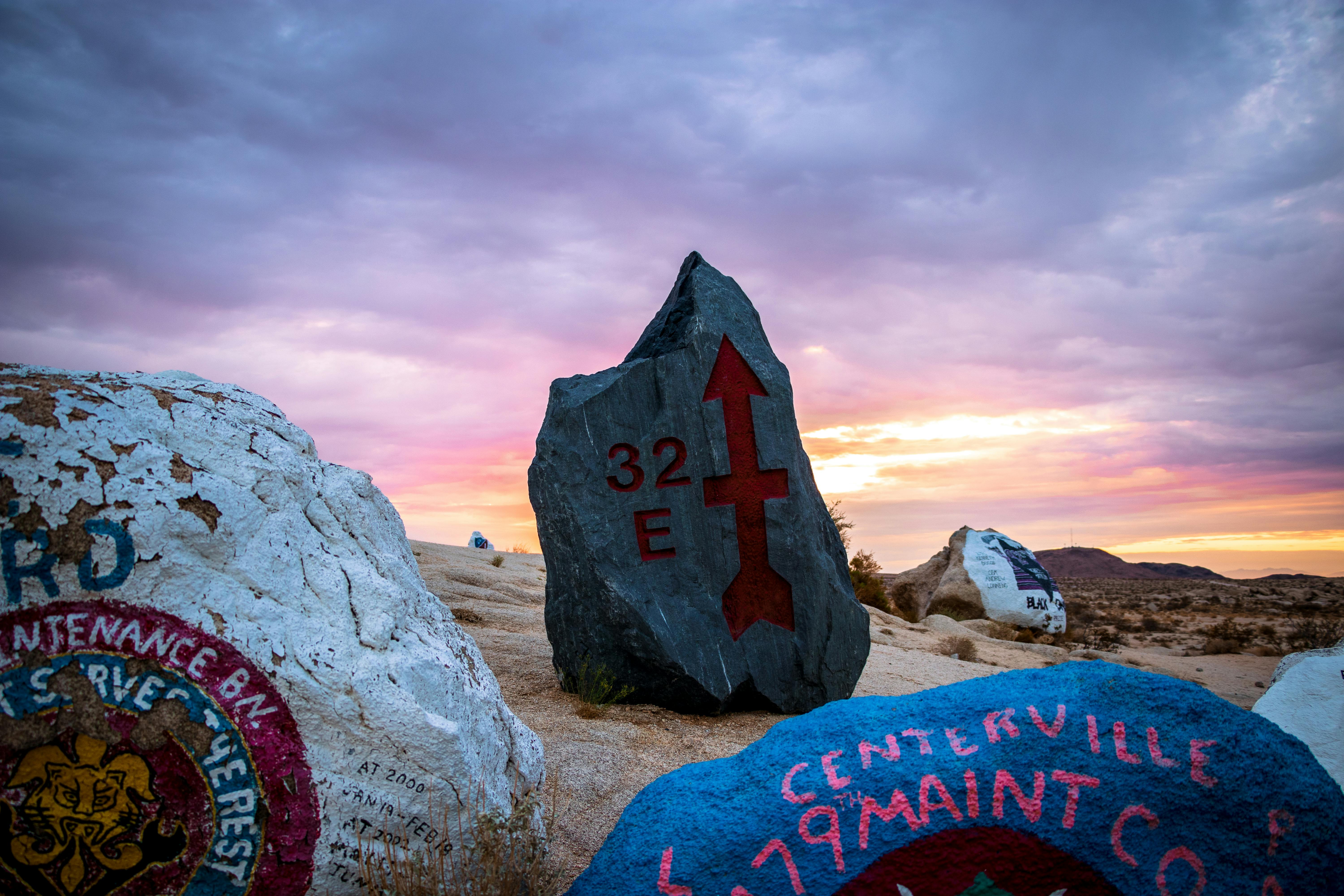 Directional Sign on a Gray Rock · Free Stock Photo