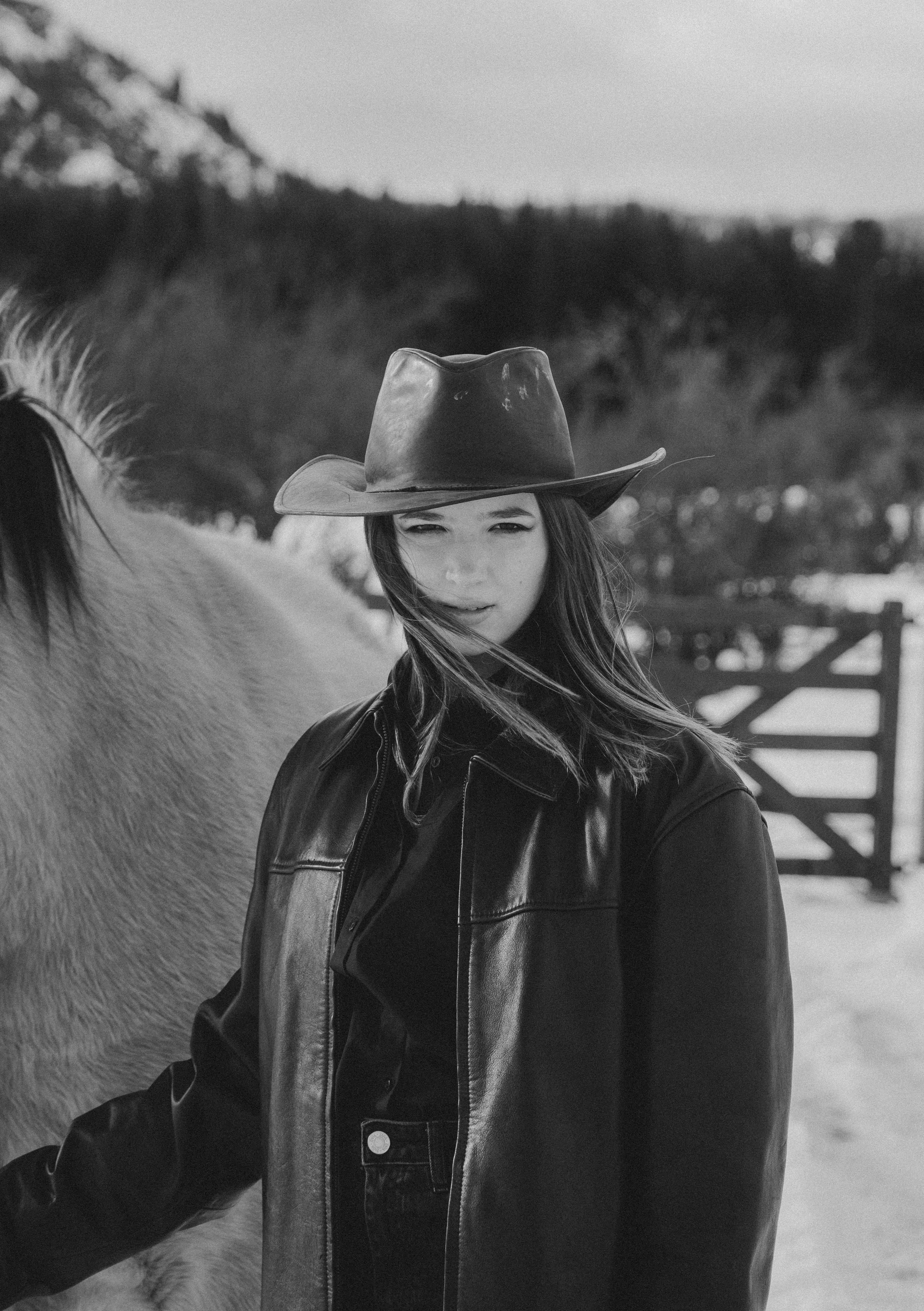 Grayscale Photo of a Woman Wearing Black Leather Jacket and Cowboy Hat ...