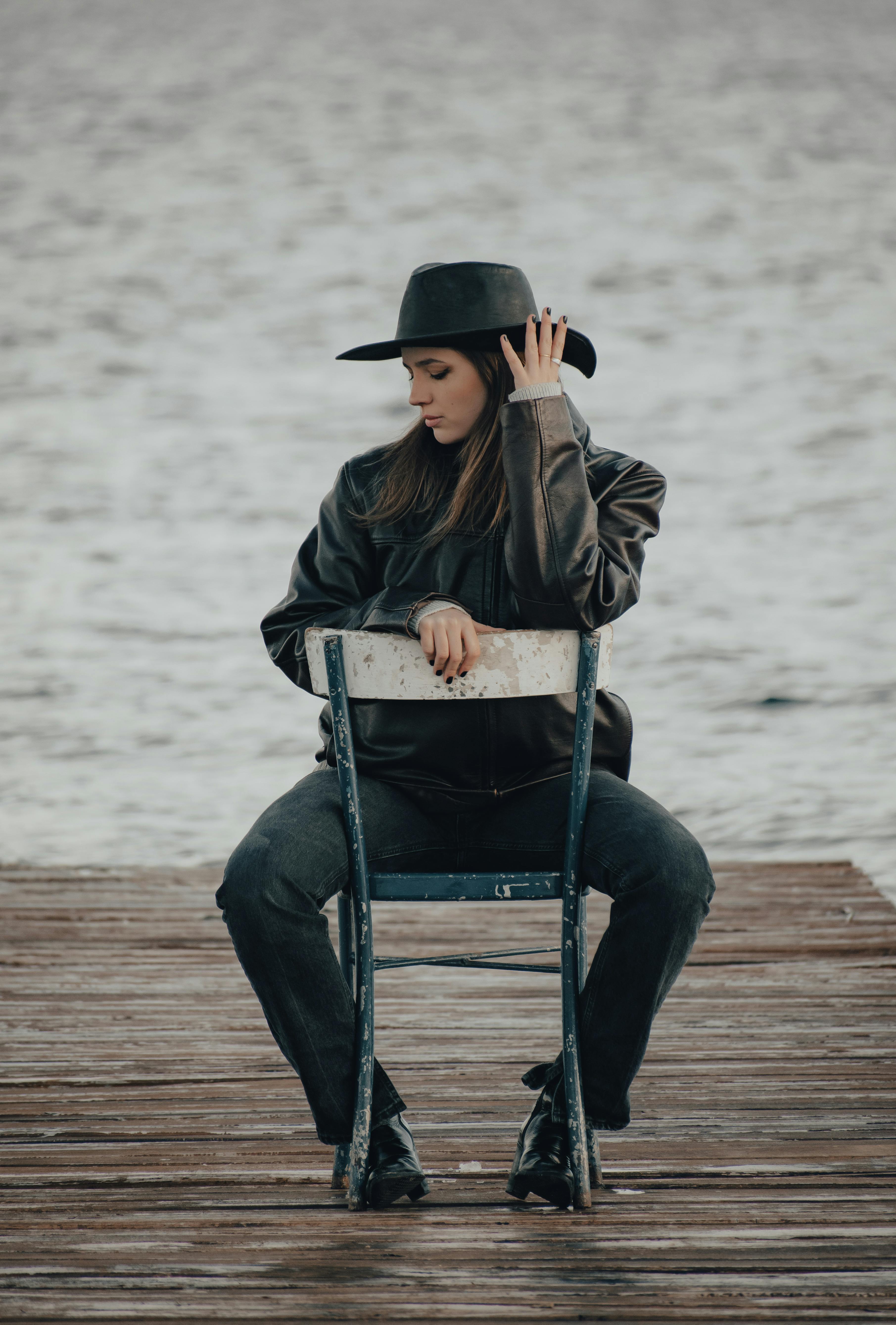 Woman in Brown Leather Jacket Sitting on the Chair · Free Stock Photo
