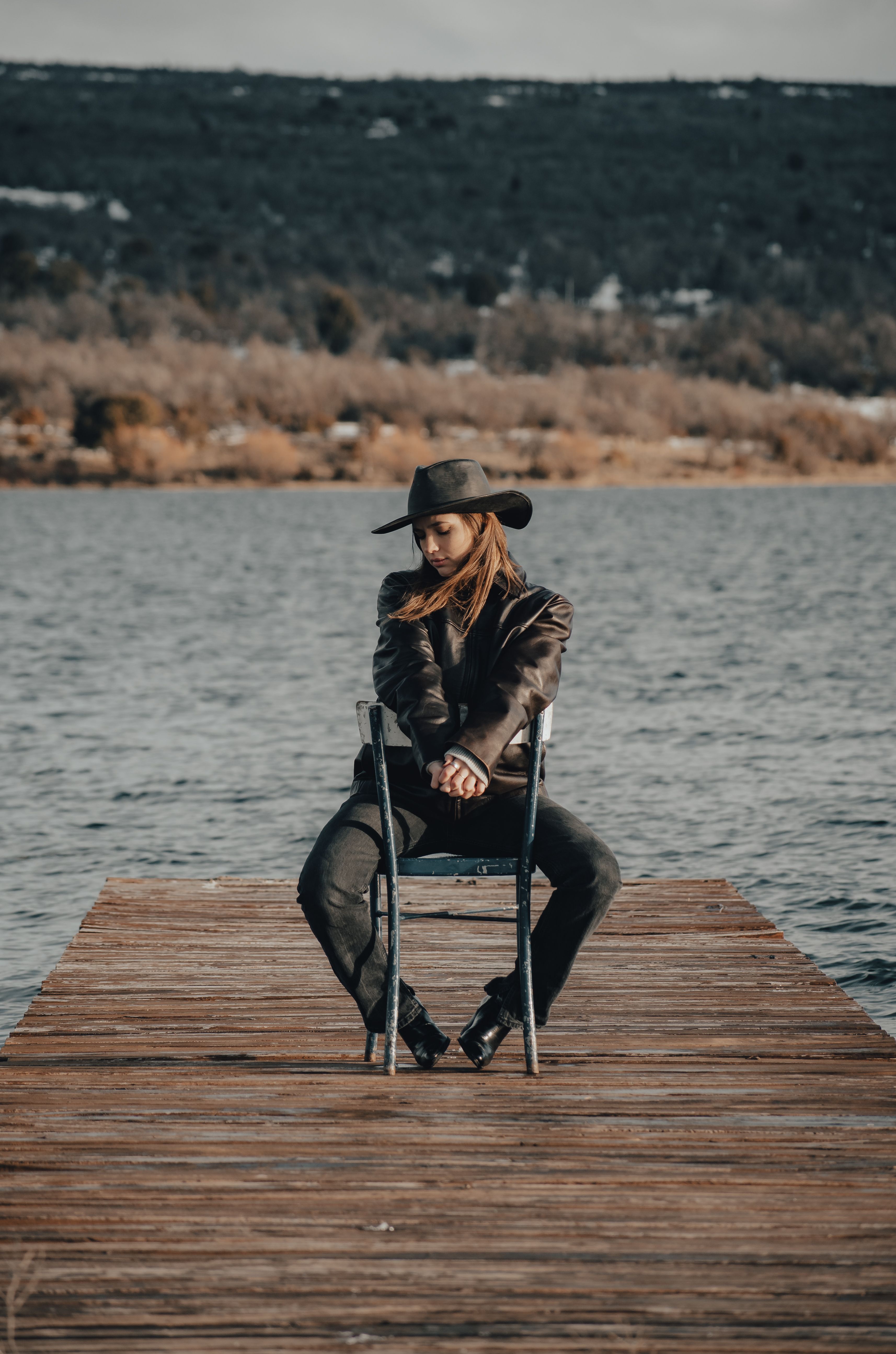 Woman in Leather Jacket Holding the Chair · Free Stock Photo