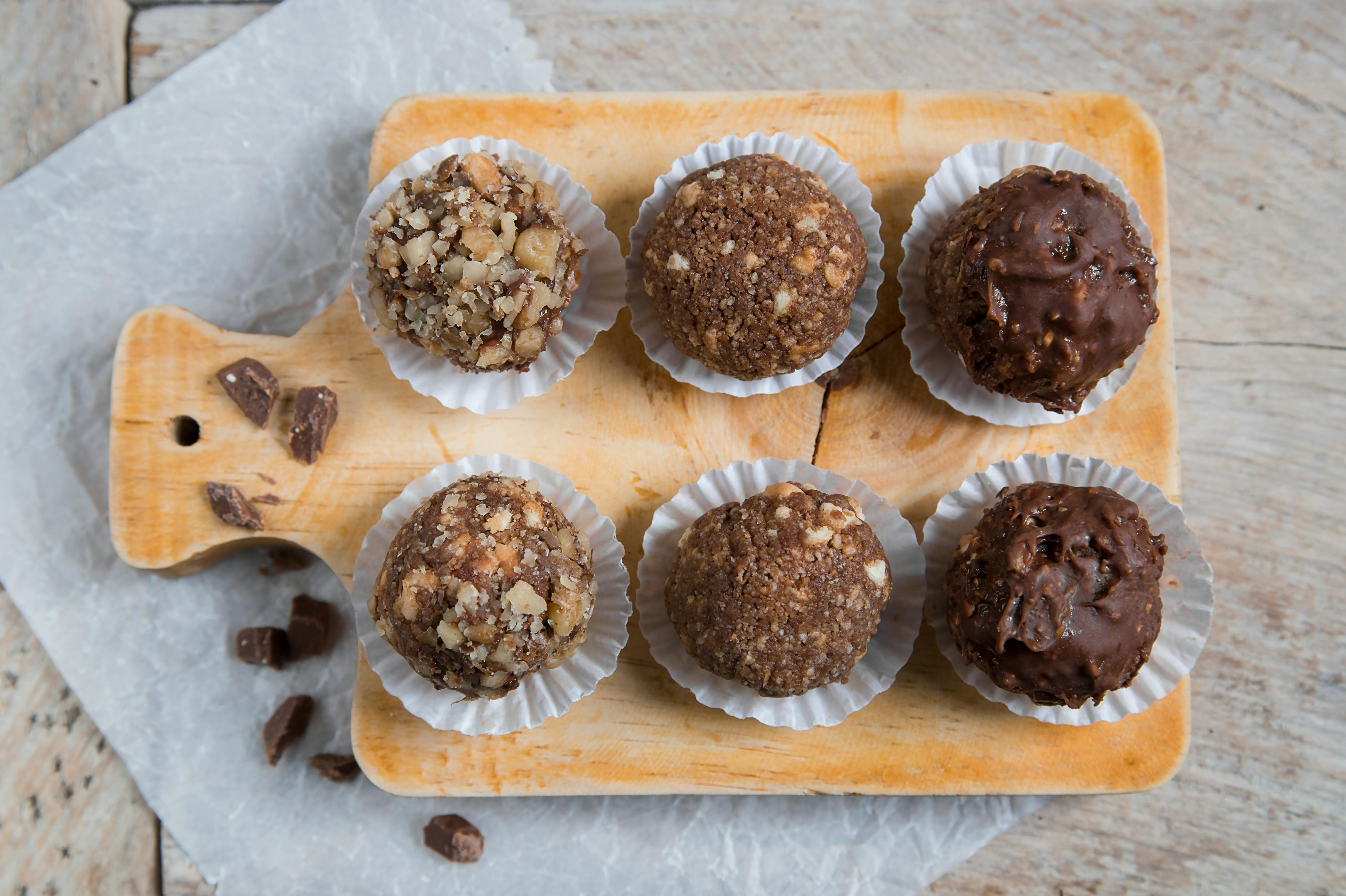 Top View of Chocolate Balls with Different Toppings on a Cutting Board ...