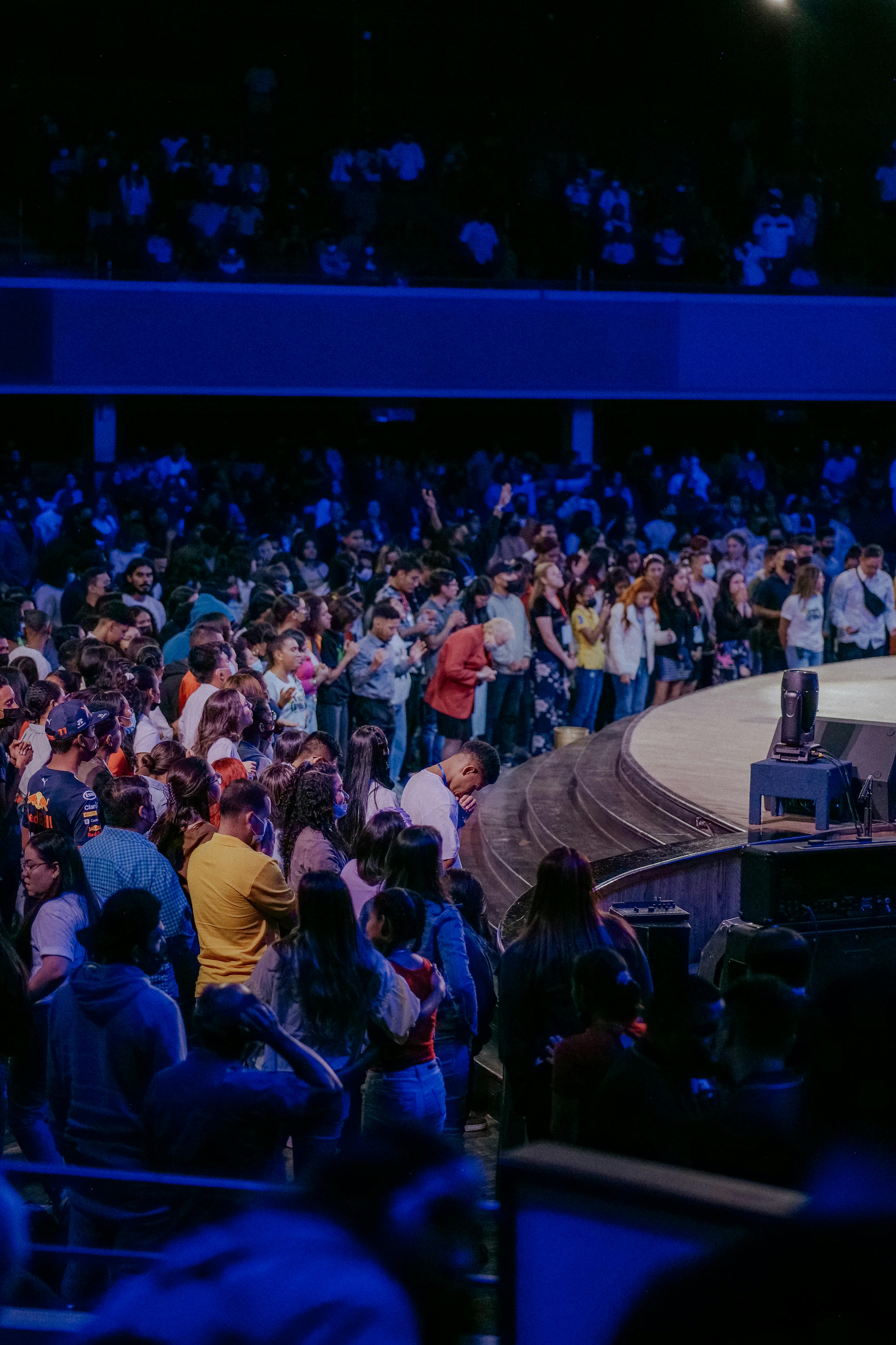 Photo of a Man Raising his Hands towards a Stage with a Cross · Free ...