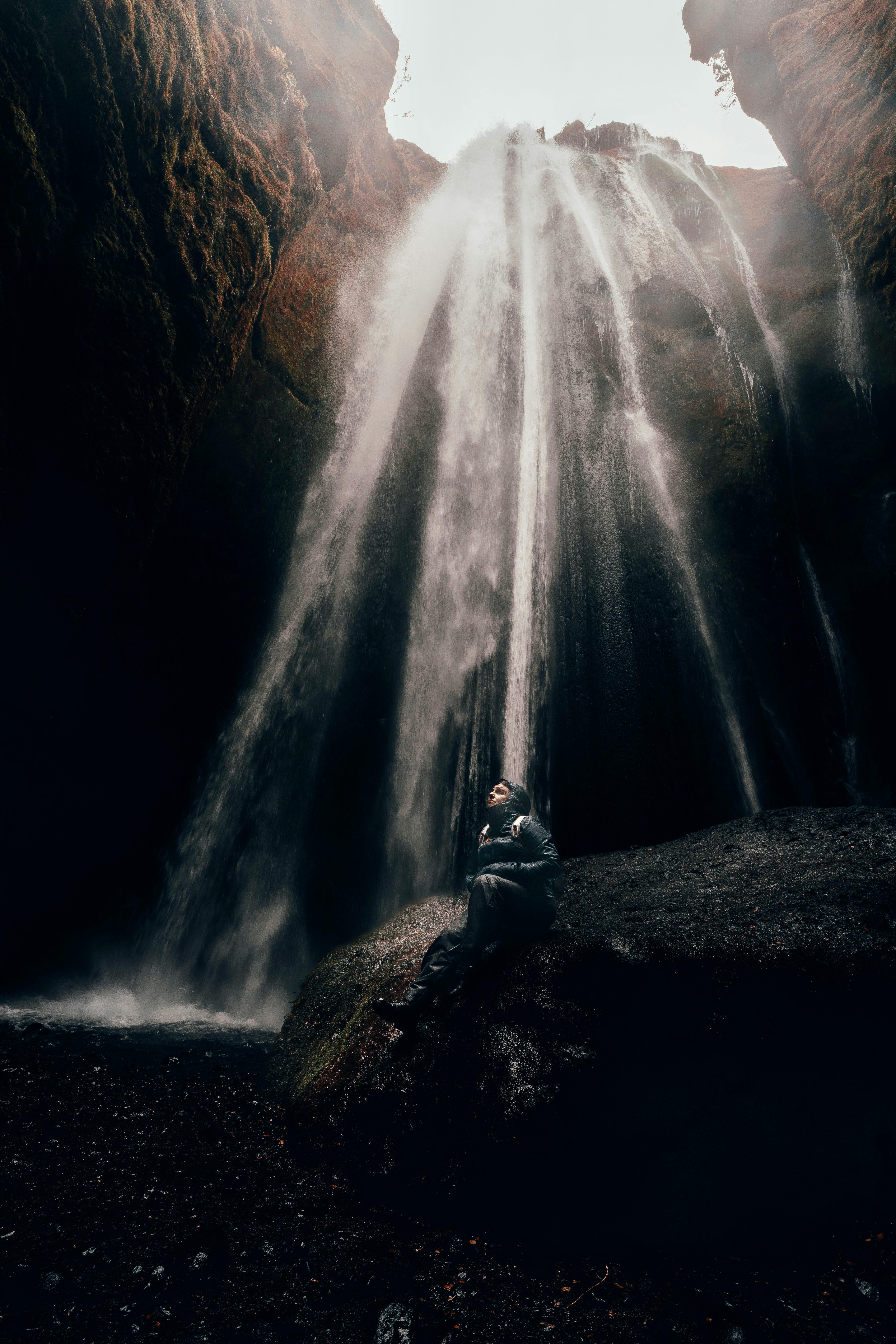 A Person Standing by a Waterfall · Free Stock Photo