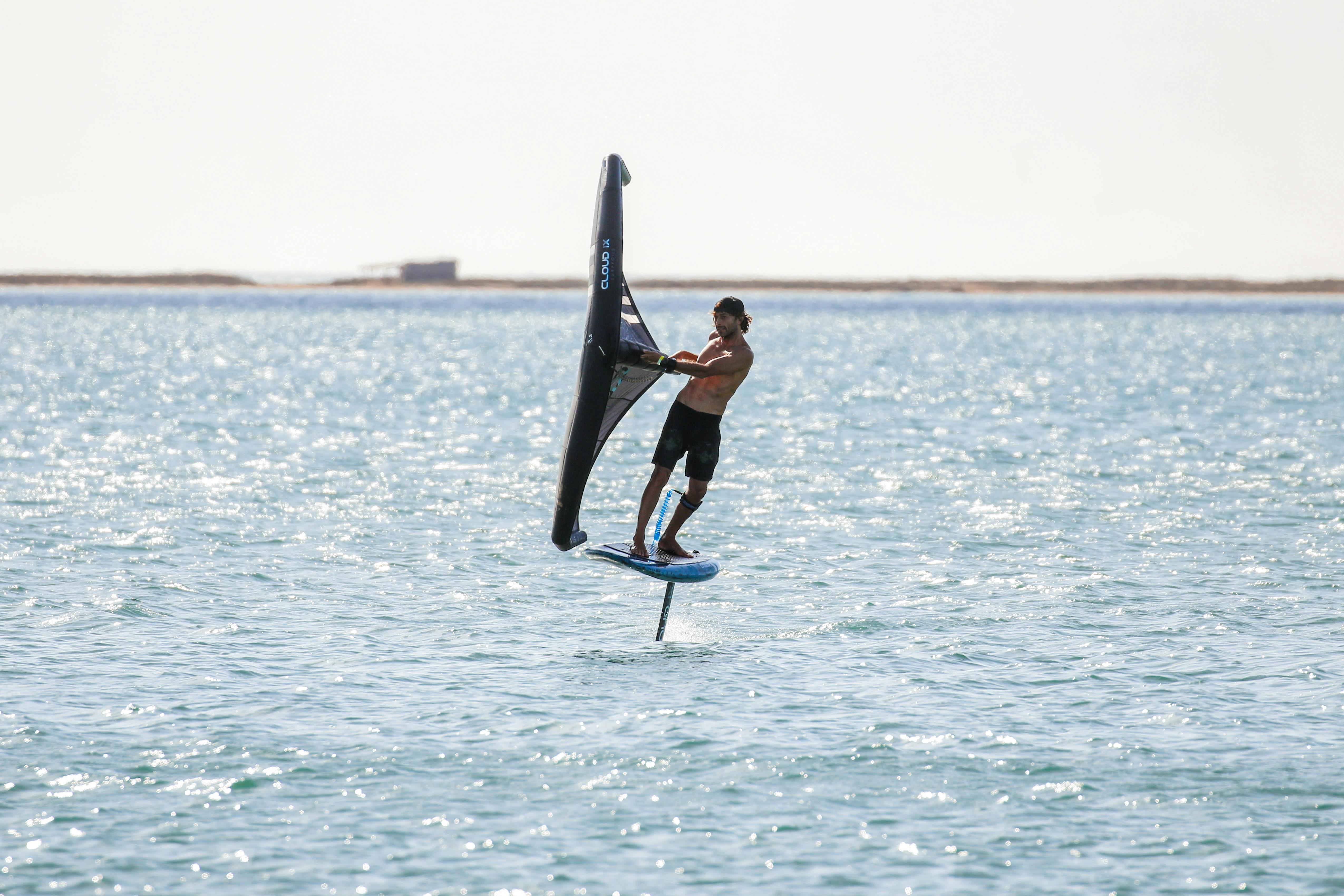 Man Wing Foiling on Board in Ocean · Free Stock Photo