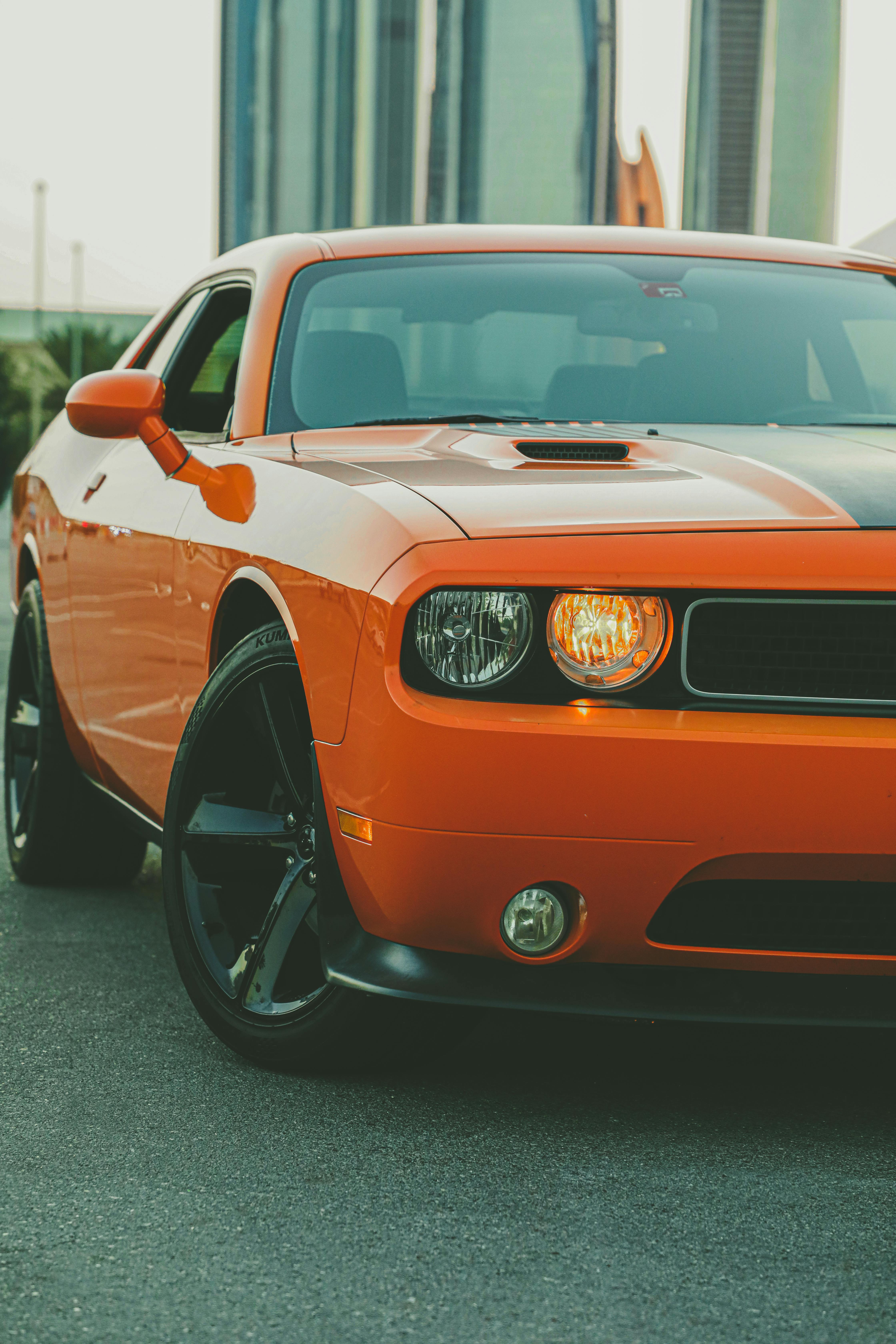 An Orange Car Parked on the Street · Free Stock Photo