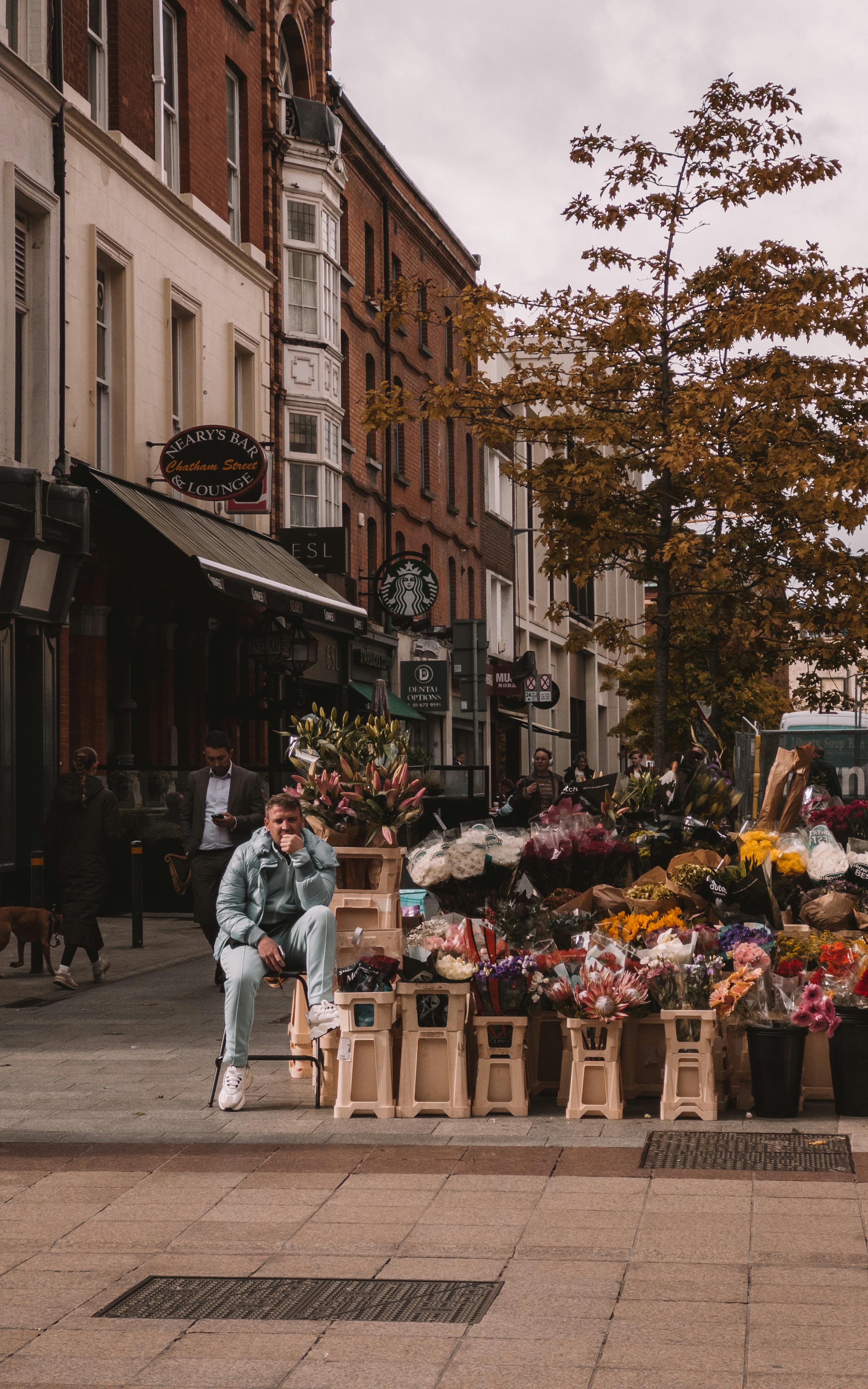 Man Selling Flowers on Sidewalk · Free Stock Photo