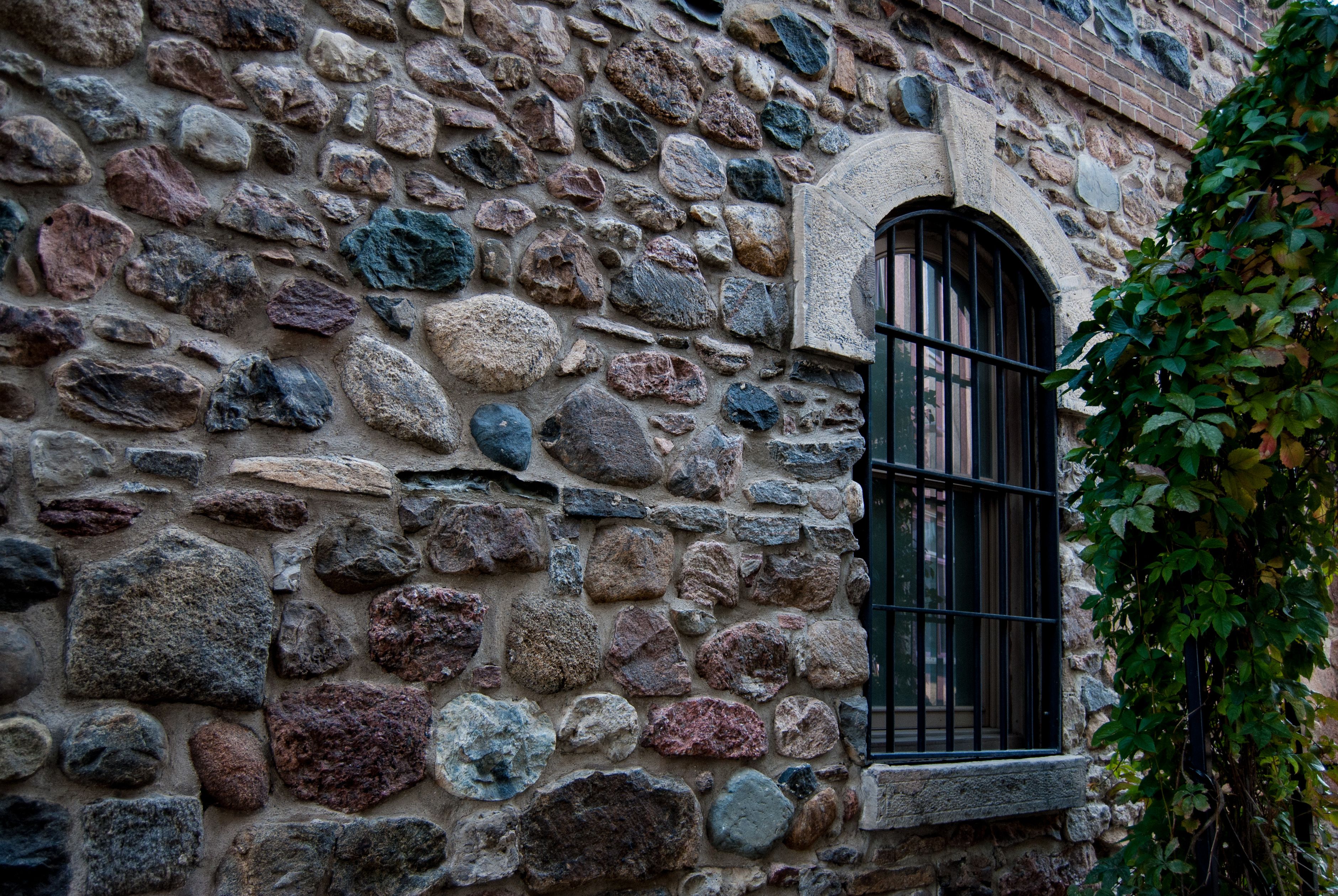 Black Metal Window Grill on Stone Wall · Free Stock Photo