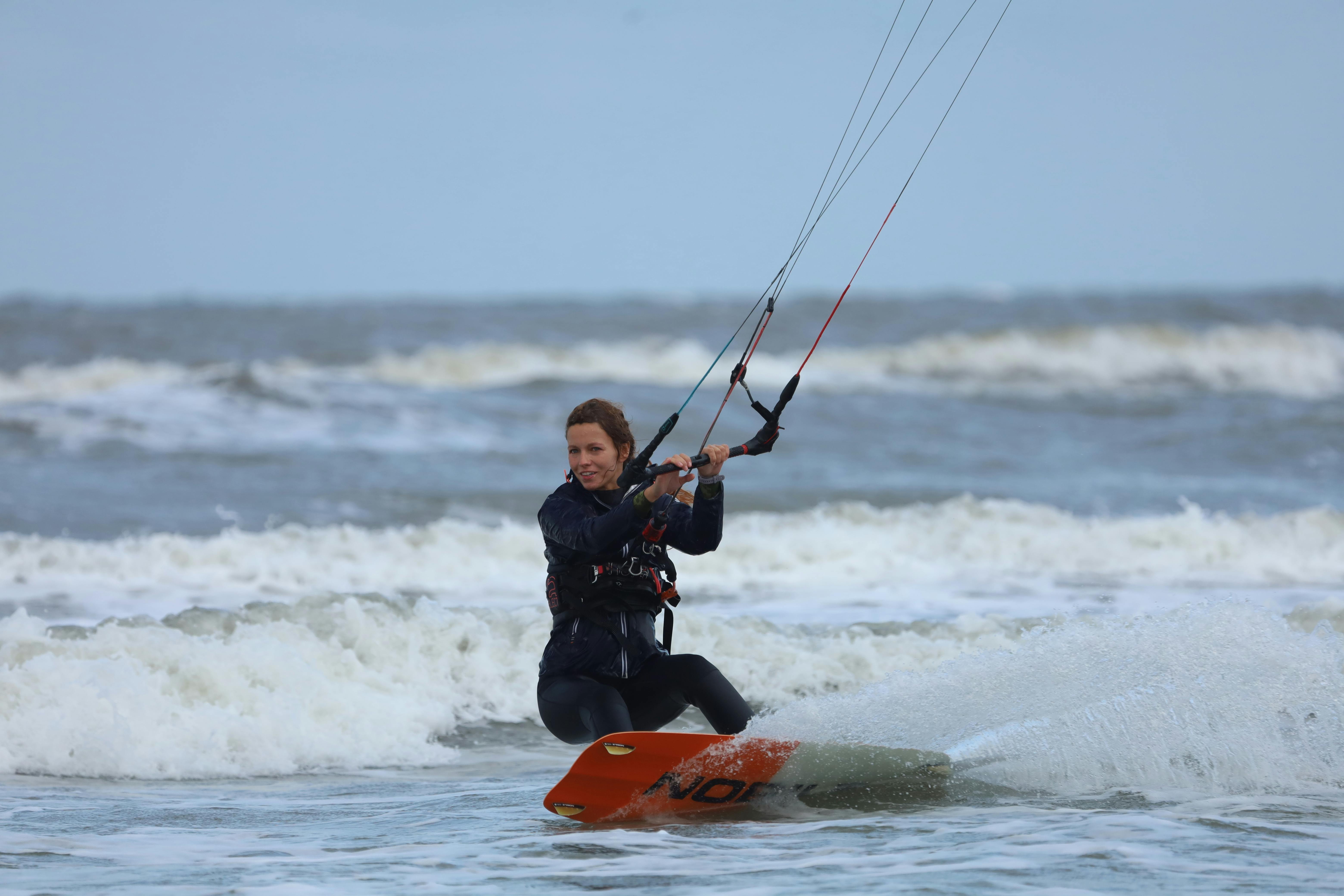 A Woman Kiteboarding on the Beach · Free Stock Photo