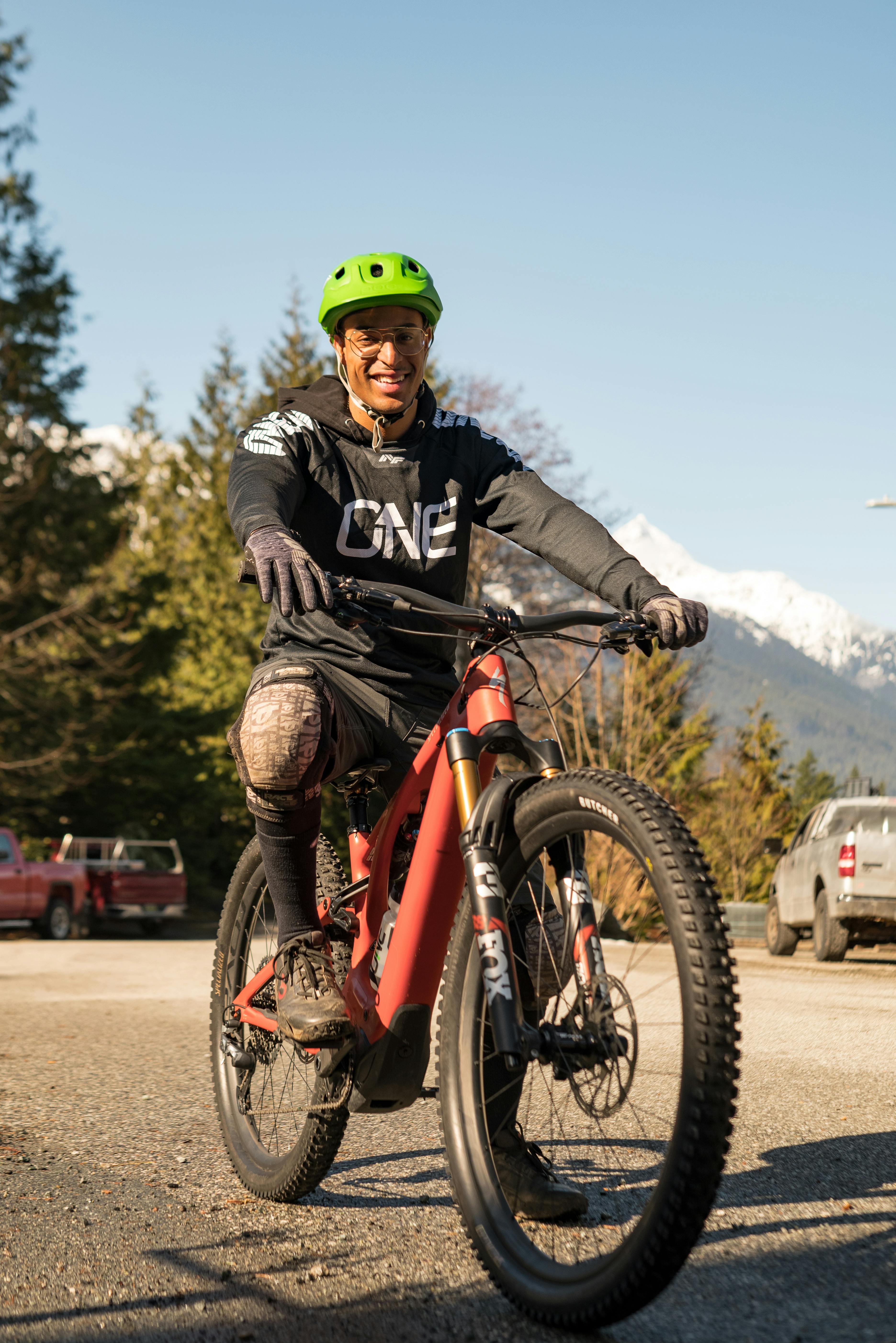 Cyclist Riding on a Berm Along a Forest Trail · Free Stock Photo