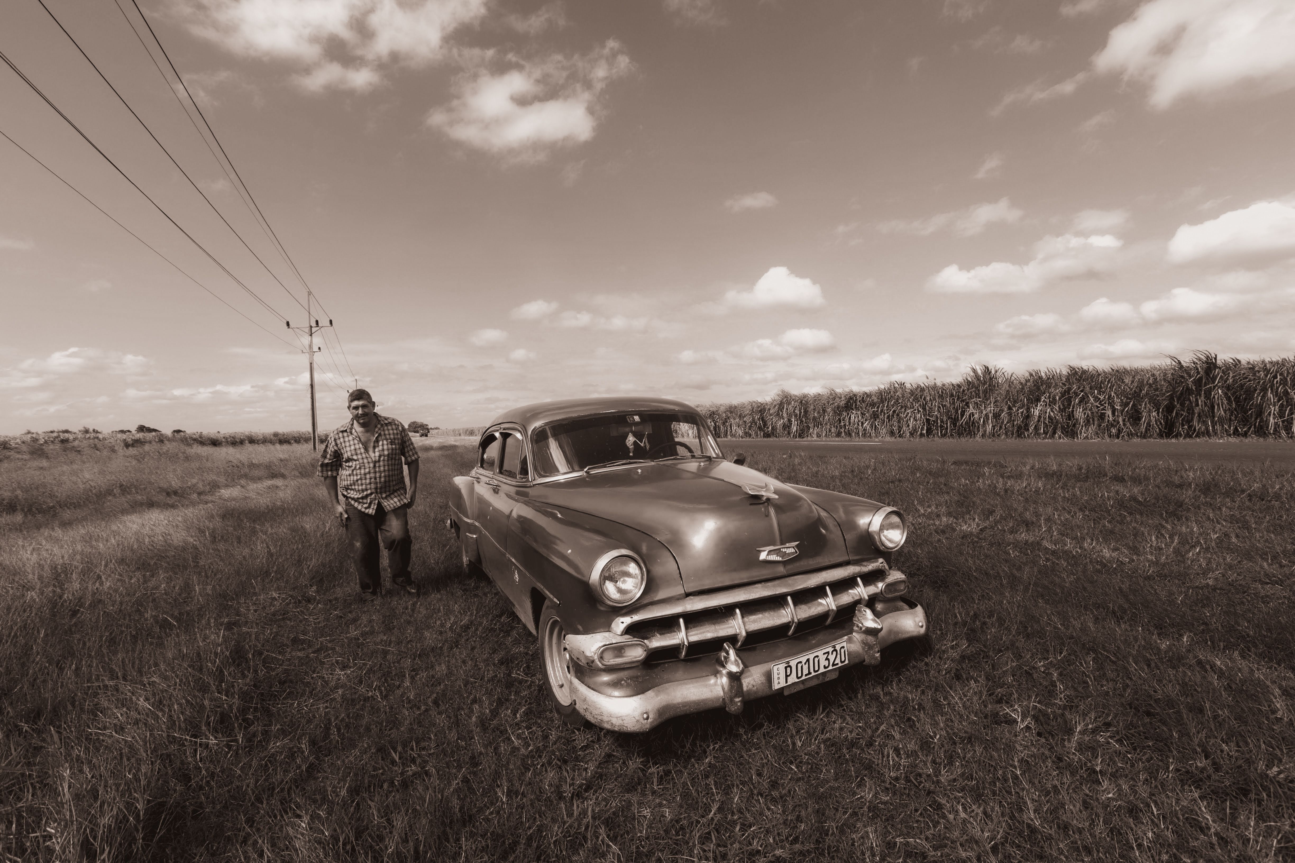 Photo of Man Standing Beside Car · Free Stock Photo