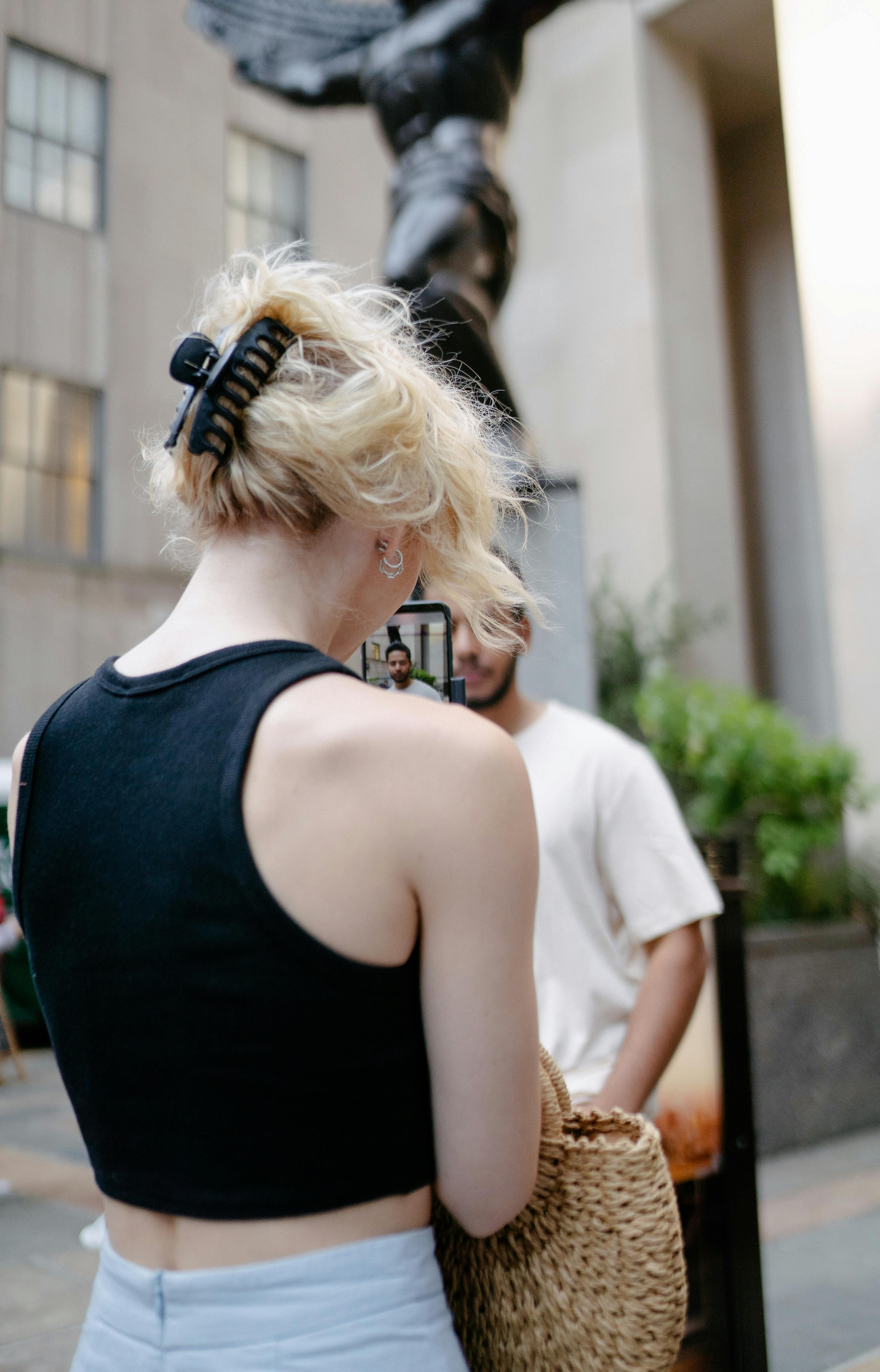 Woman and Man Pinning Images on Wall · Free Stock Photo