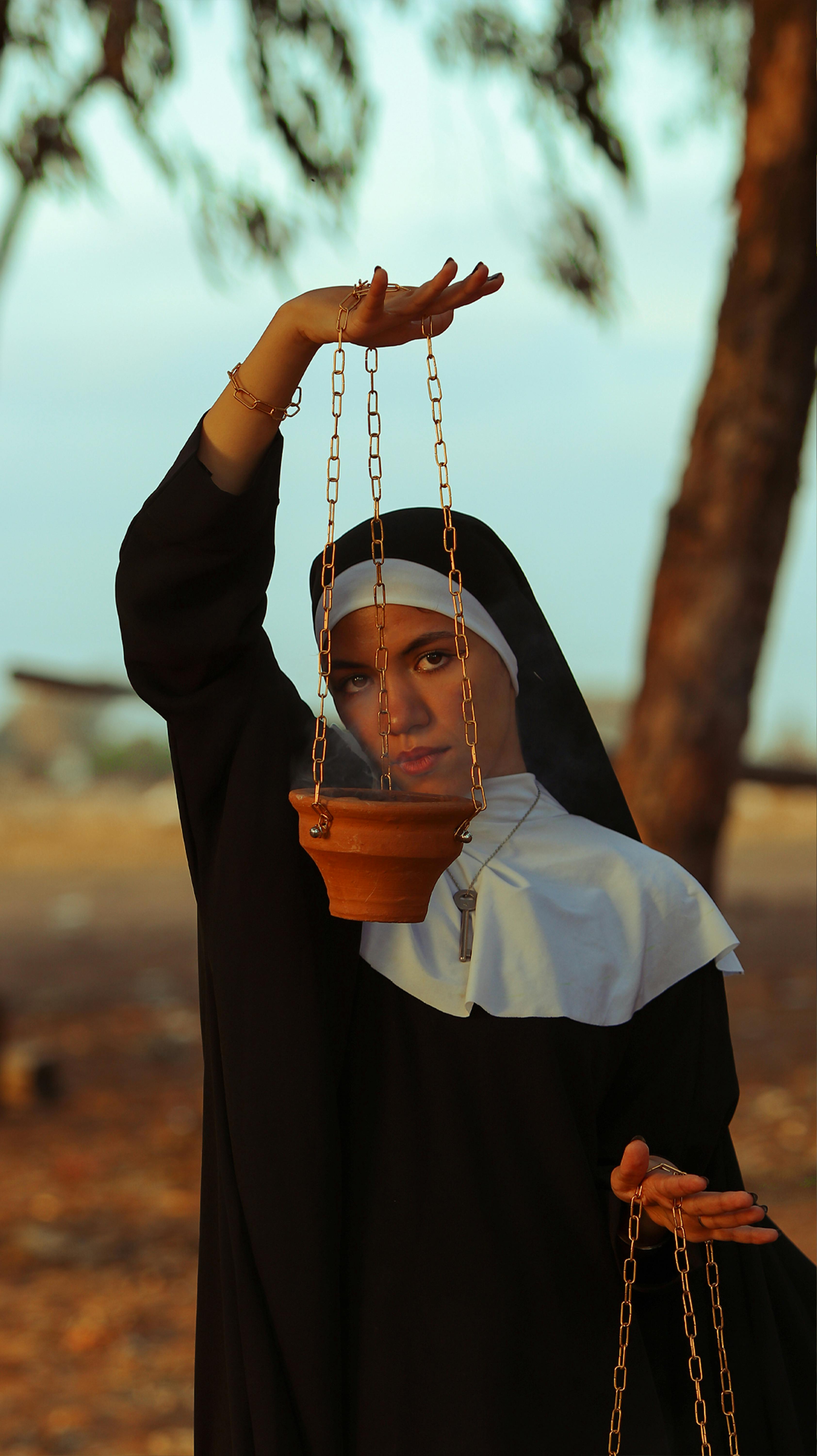Nun Reading a Bible in the Dark · Free Stock Photo