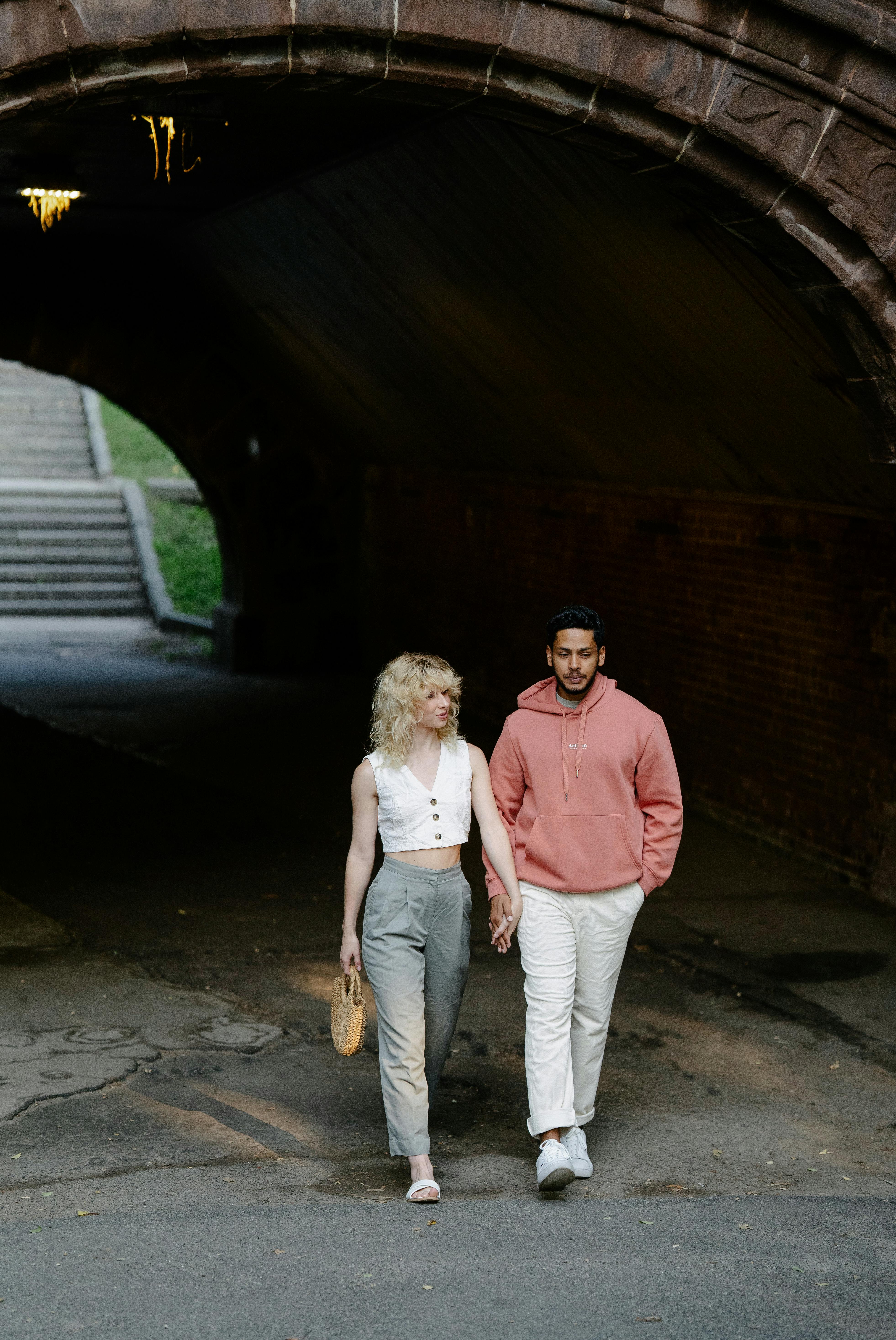 A Couple Walking while Holding Hands · Free Stock Photo