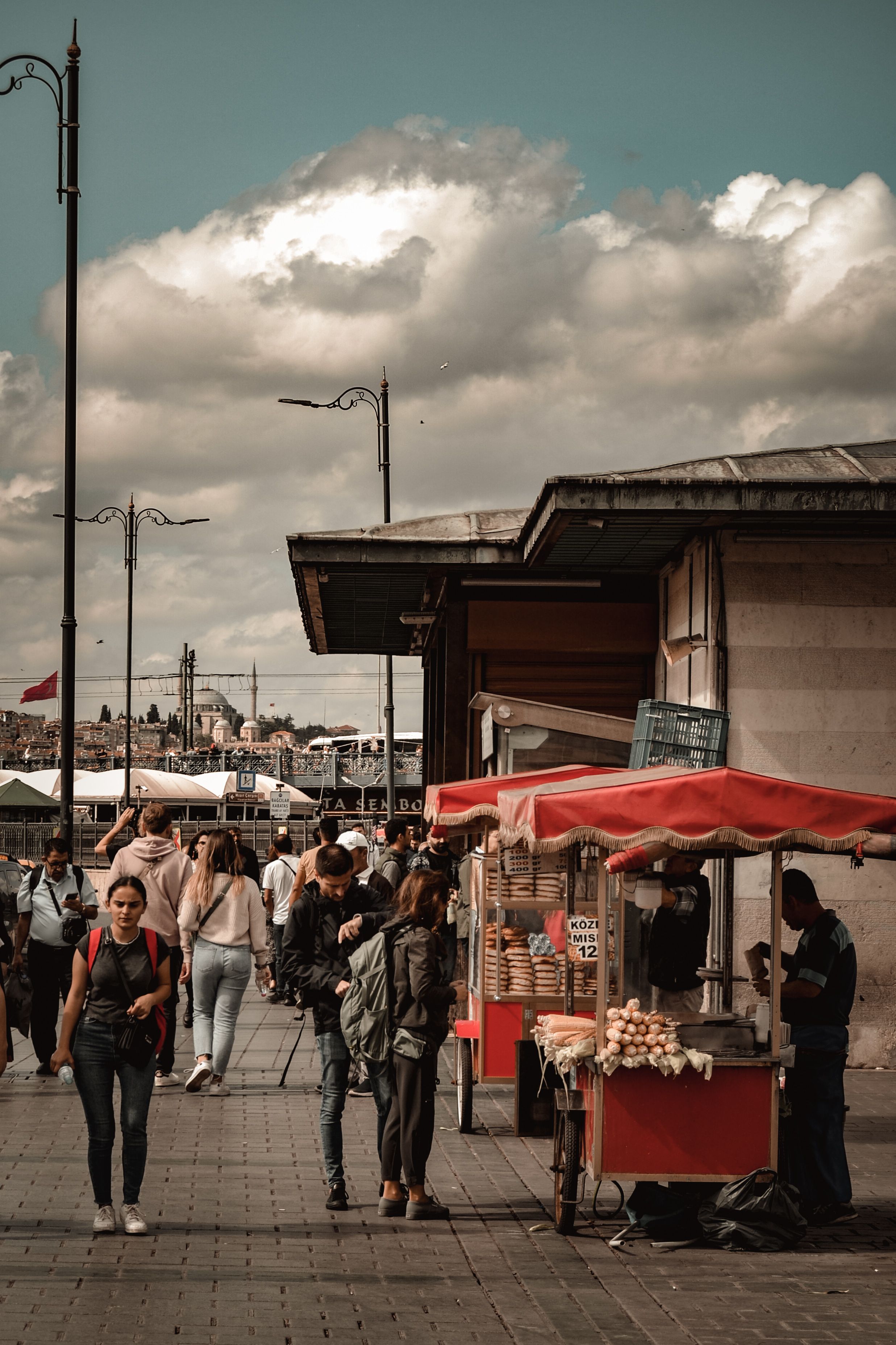 People Walking on Street Near Concrete Building · Free Stock Photo